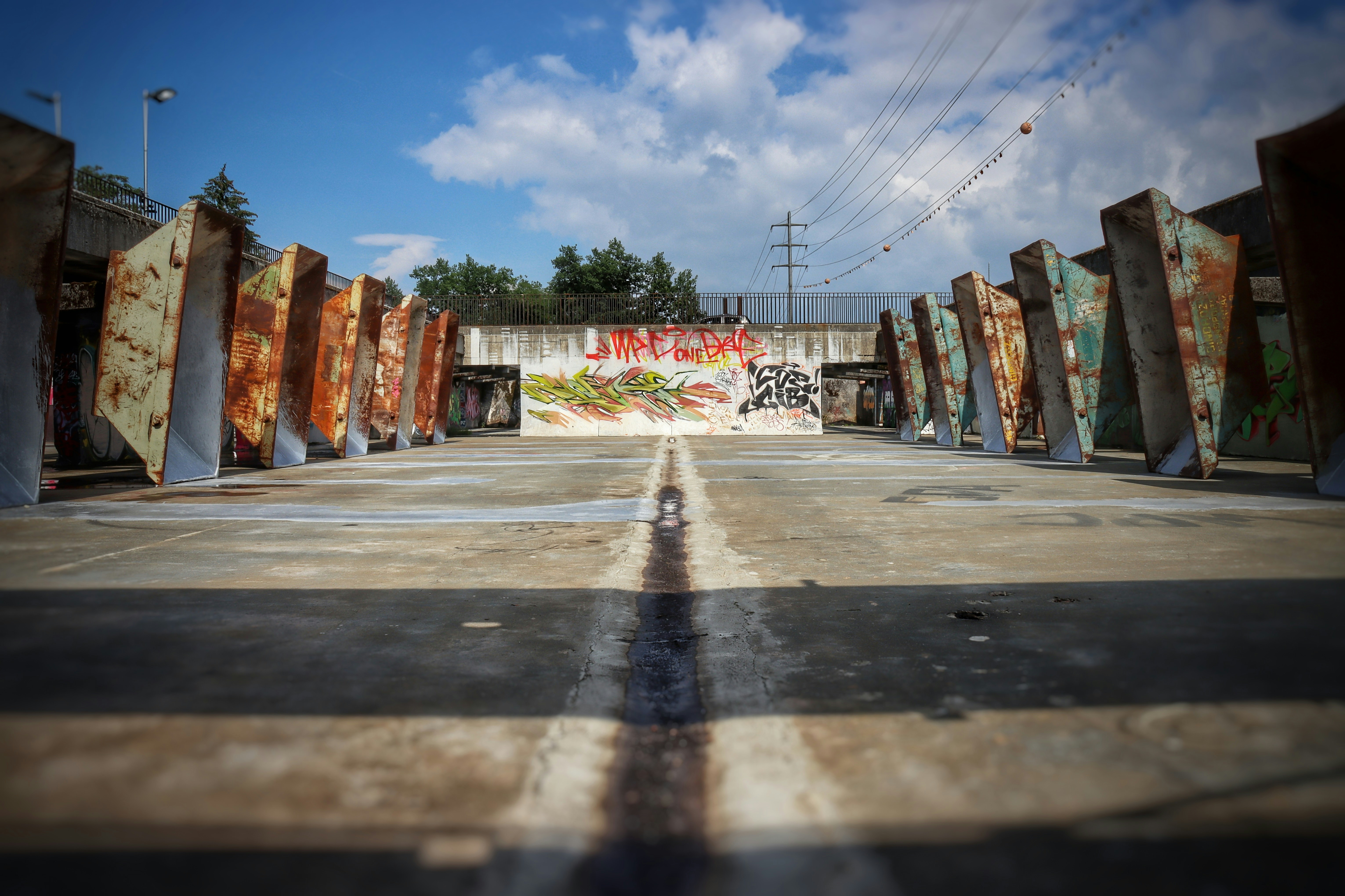 an empty parking lot with graffiti on the walls