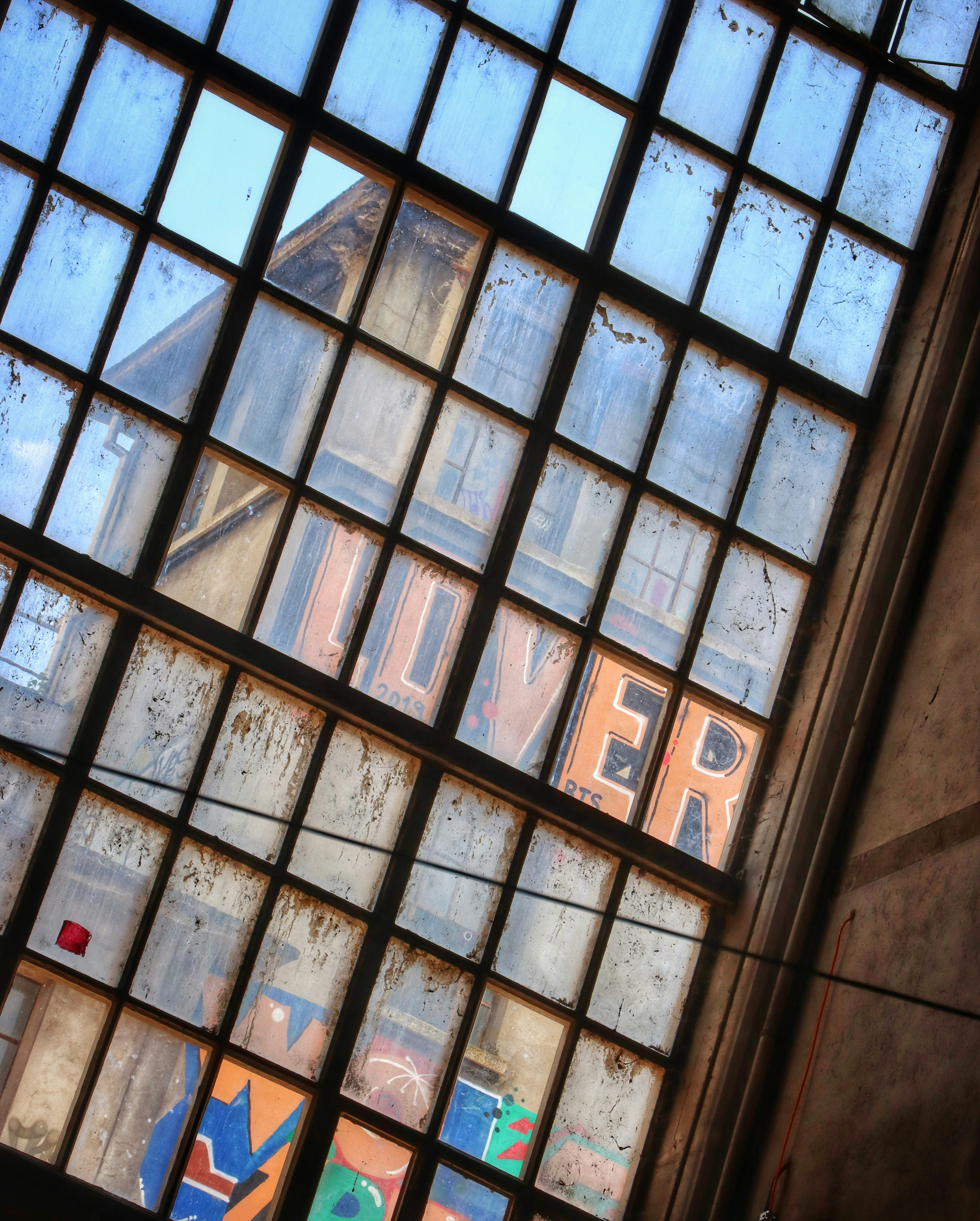 A view of a building through a glass window photo – Free Riedholz Image ...
