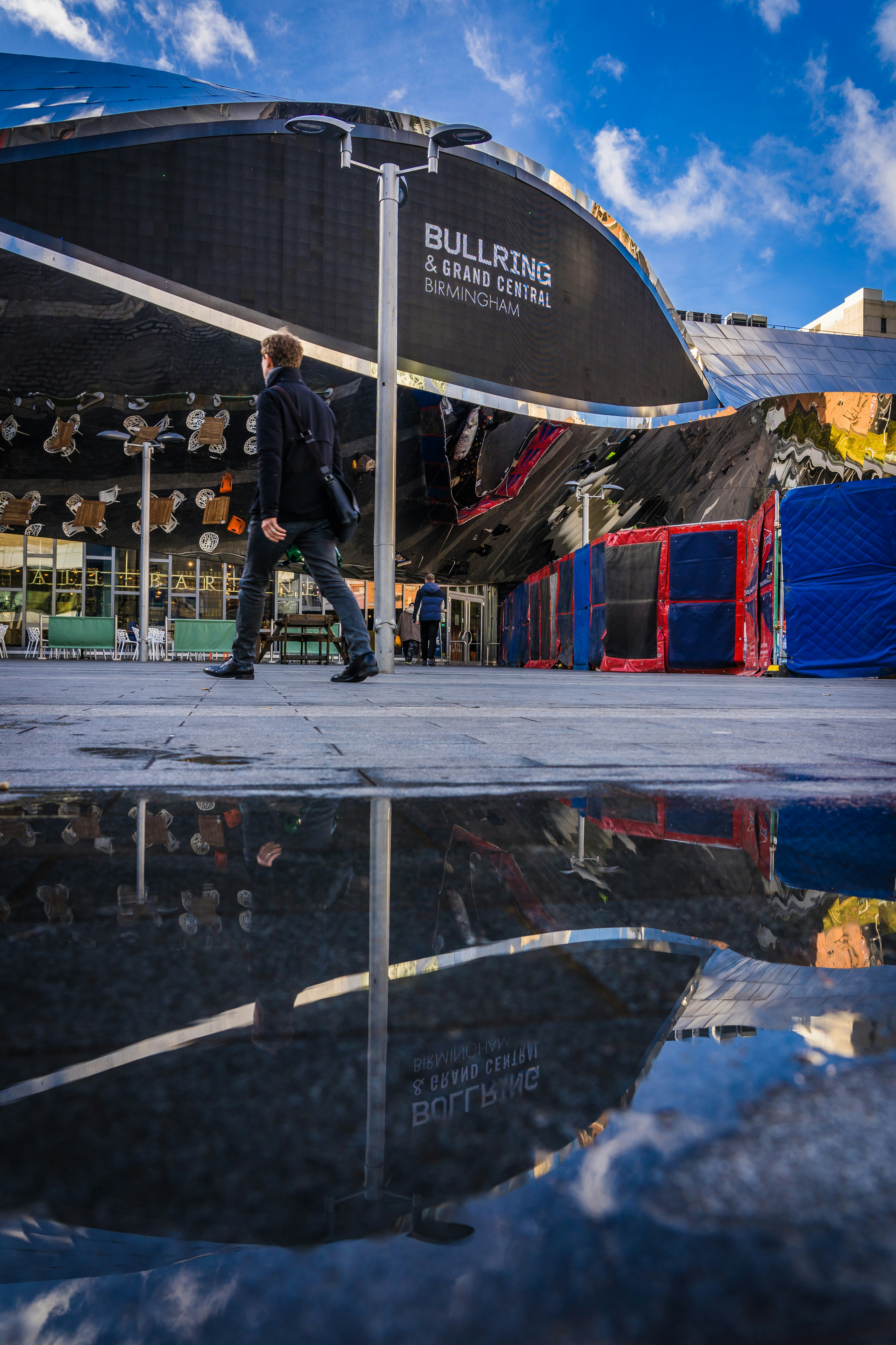 a man walking in front of a building