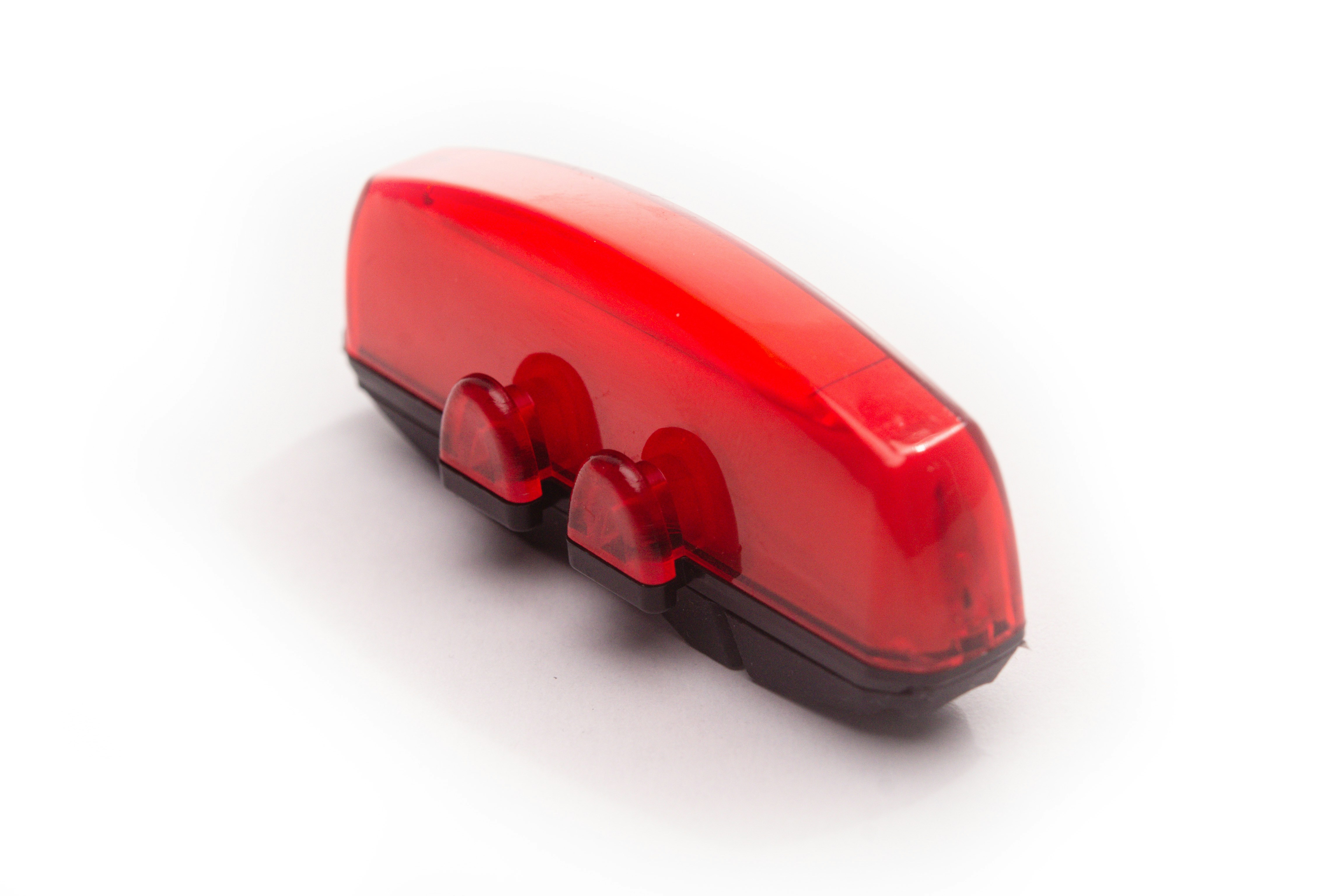 a close up of a red object on a white surface