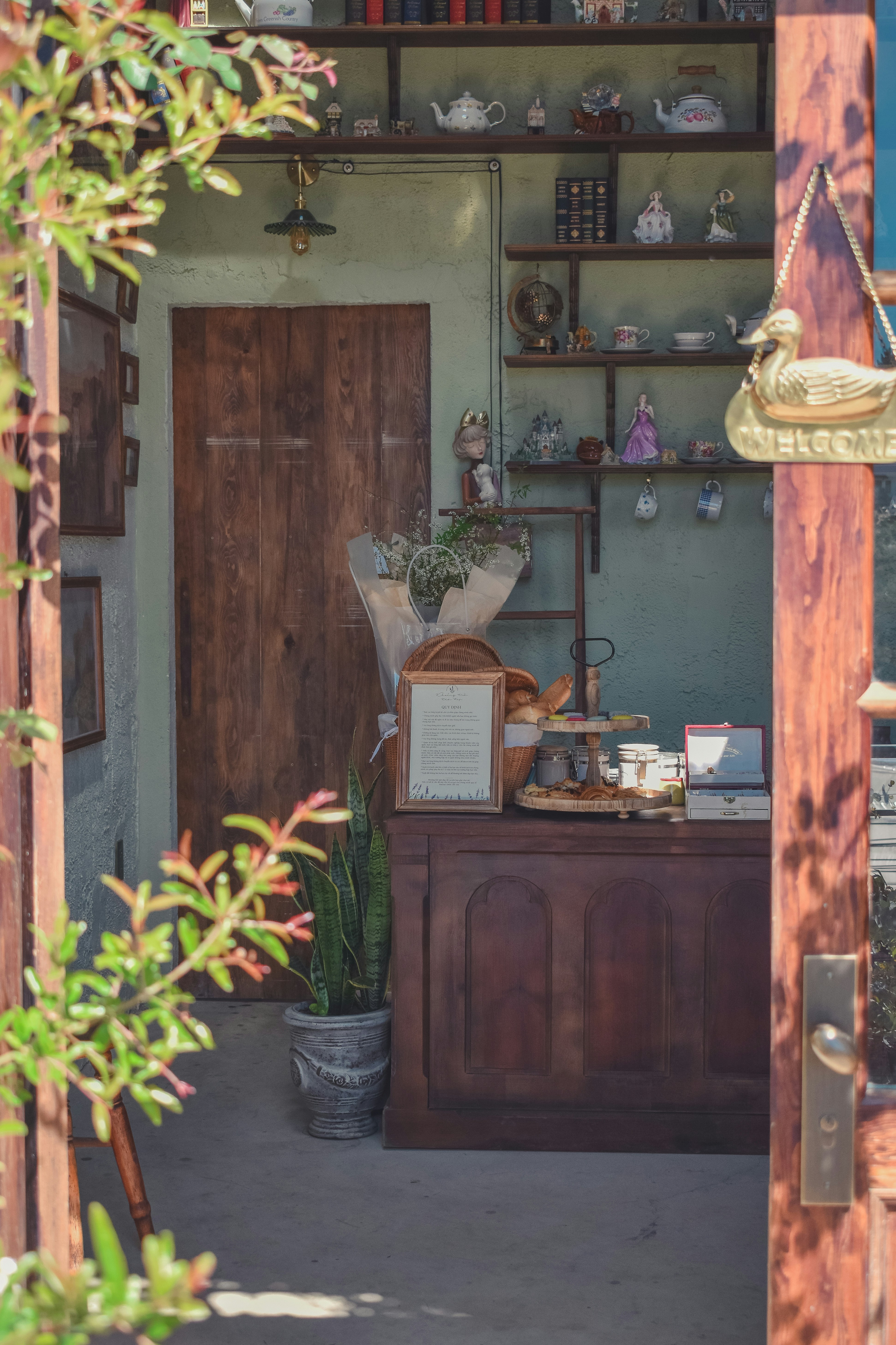 Charming interior of a quaint shop featuring wooden counters, decorative shelves, and fresh flowers. The inviting atmosphere suggests a focus on artisanal goods.