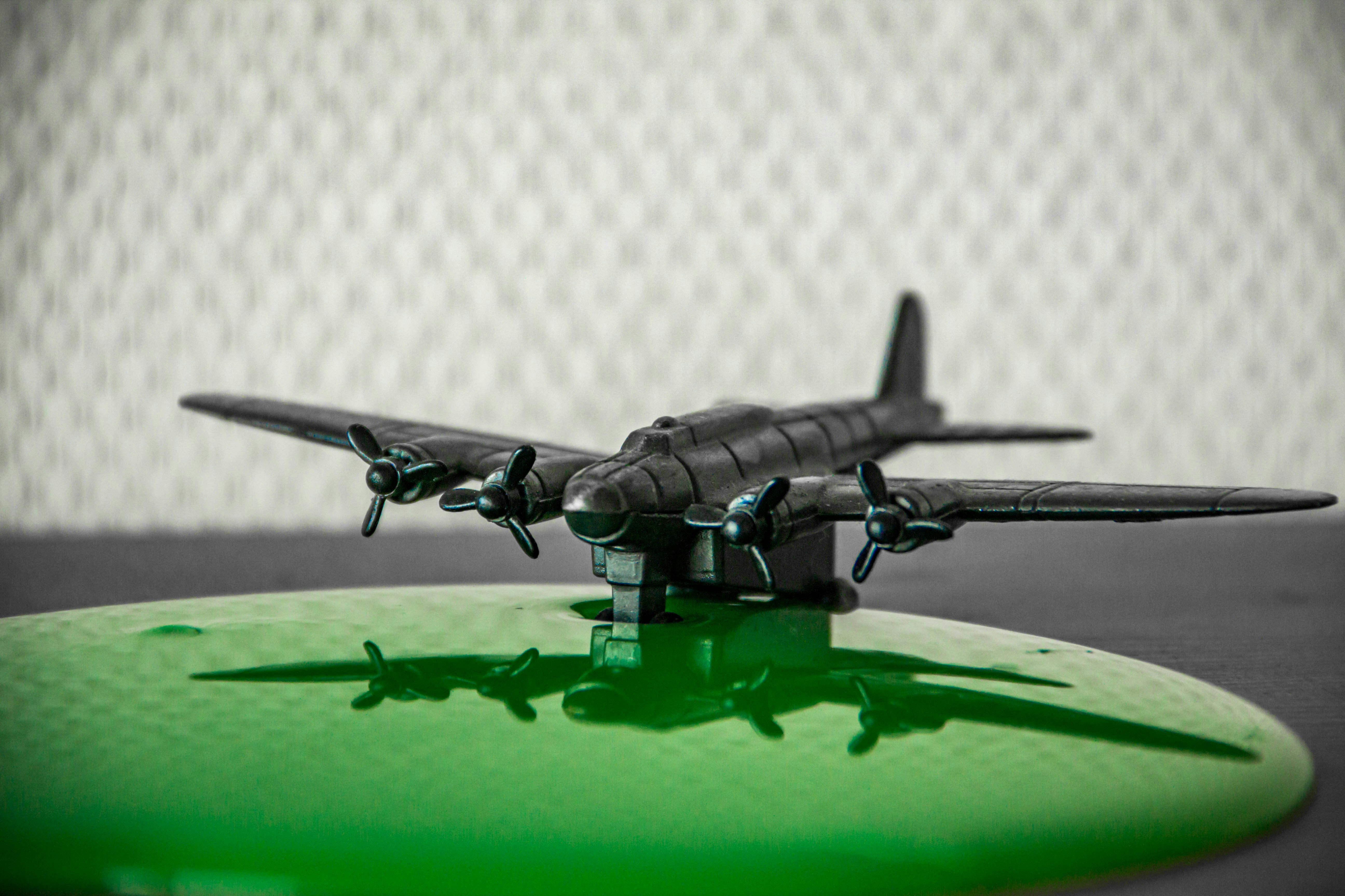 Miniature Aircraft Touchdown on Emerald Surface