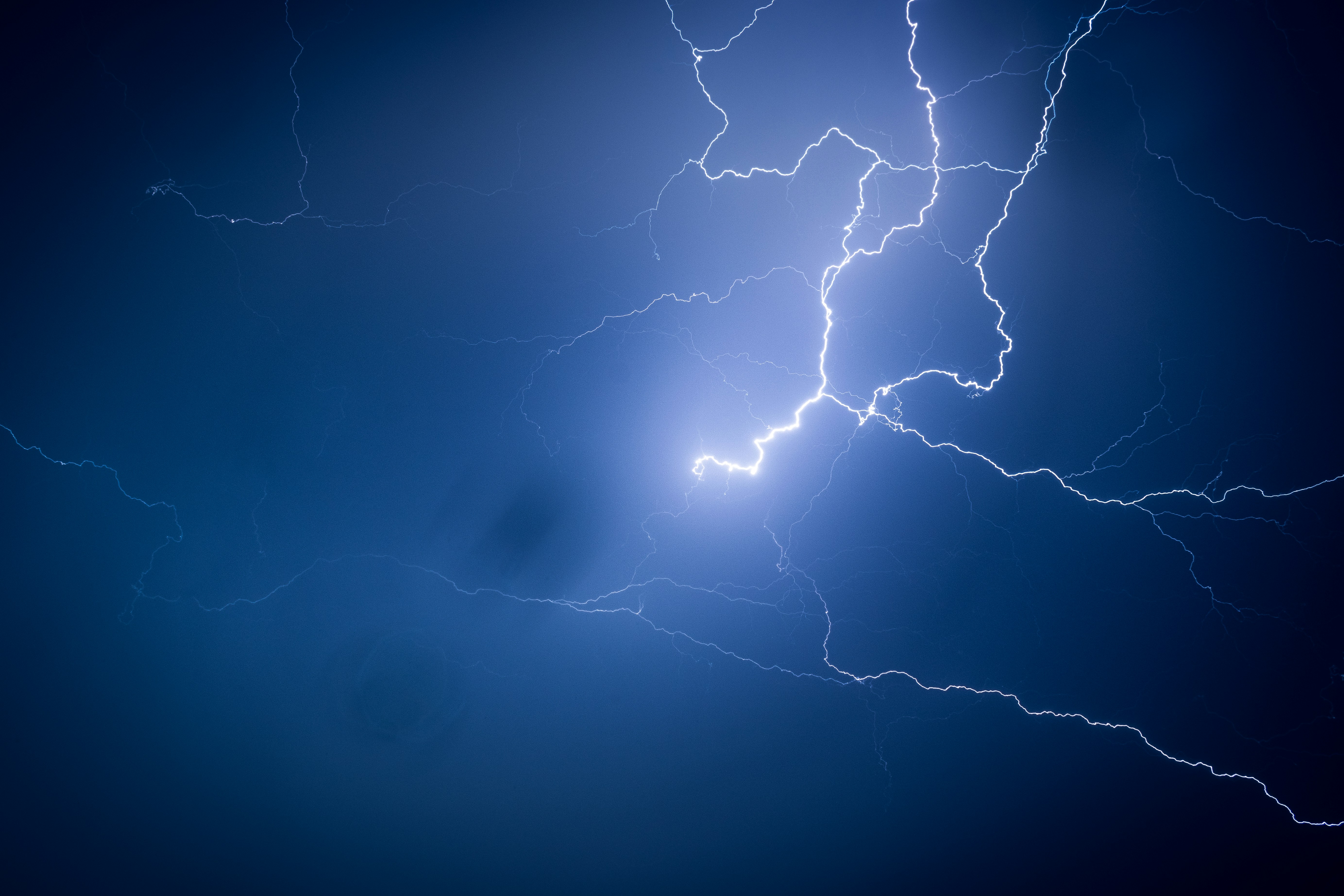 A lightning bolt is shown in the dark blue sky photo – Free ...