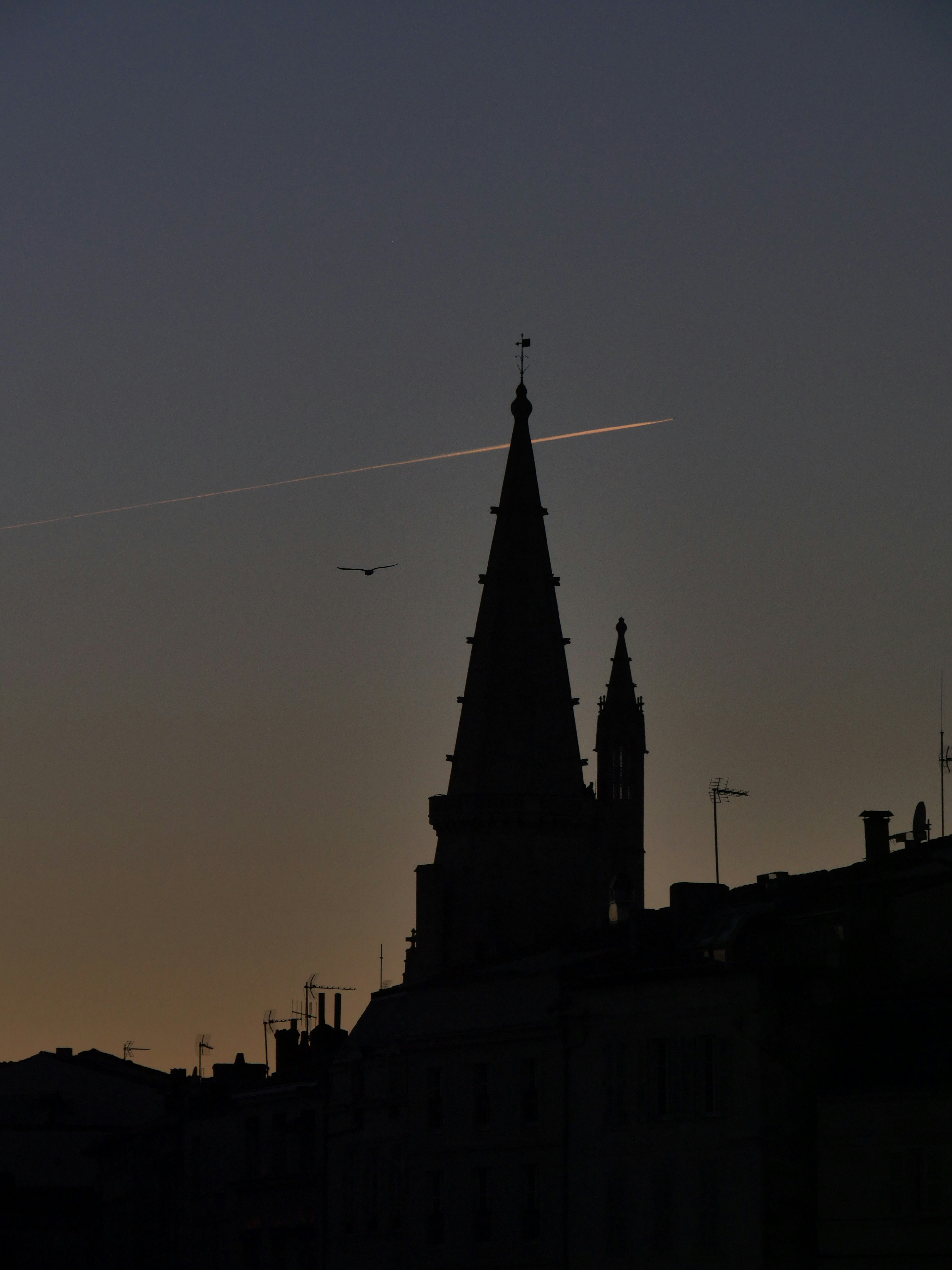 Evening Spire Serenade: A City Silhouette Against a Dusk-Blue Sky