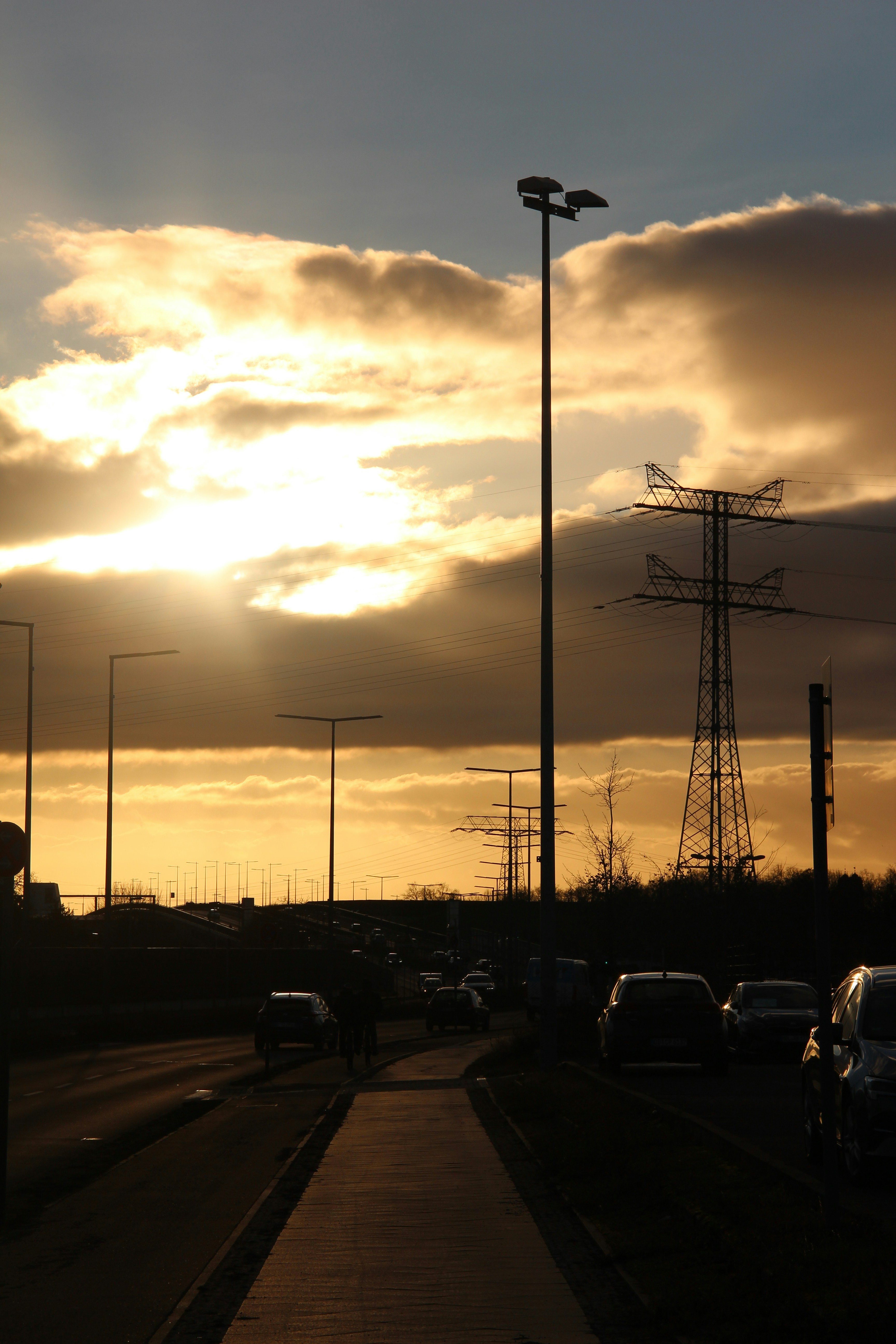 the sun is setting over a city street