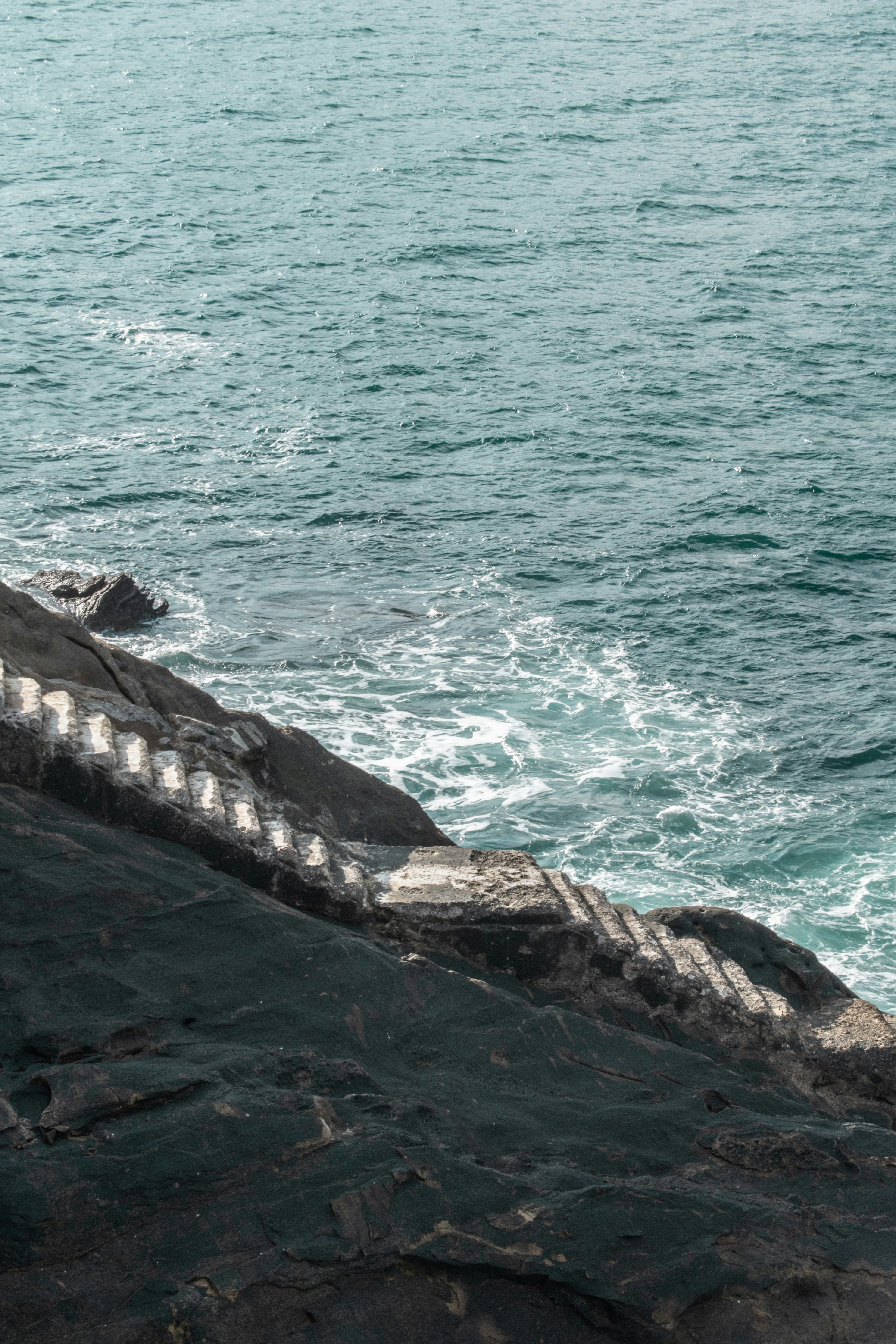 Rocky Staircase Descends Toward Turbulent Surf
