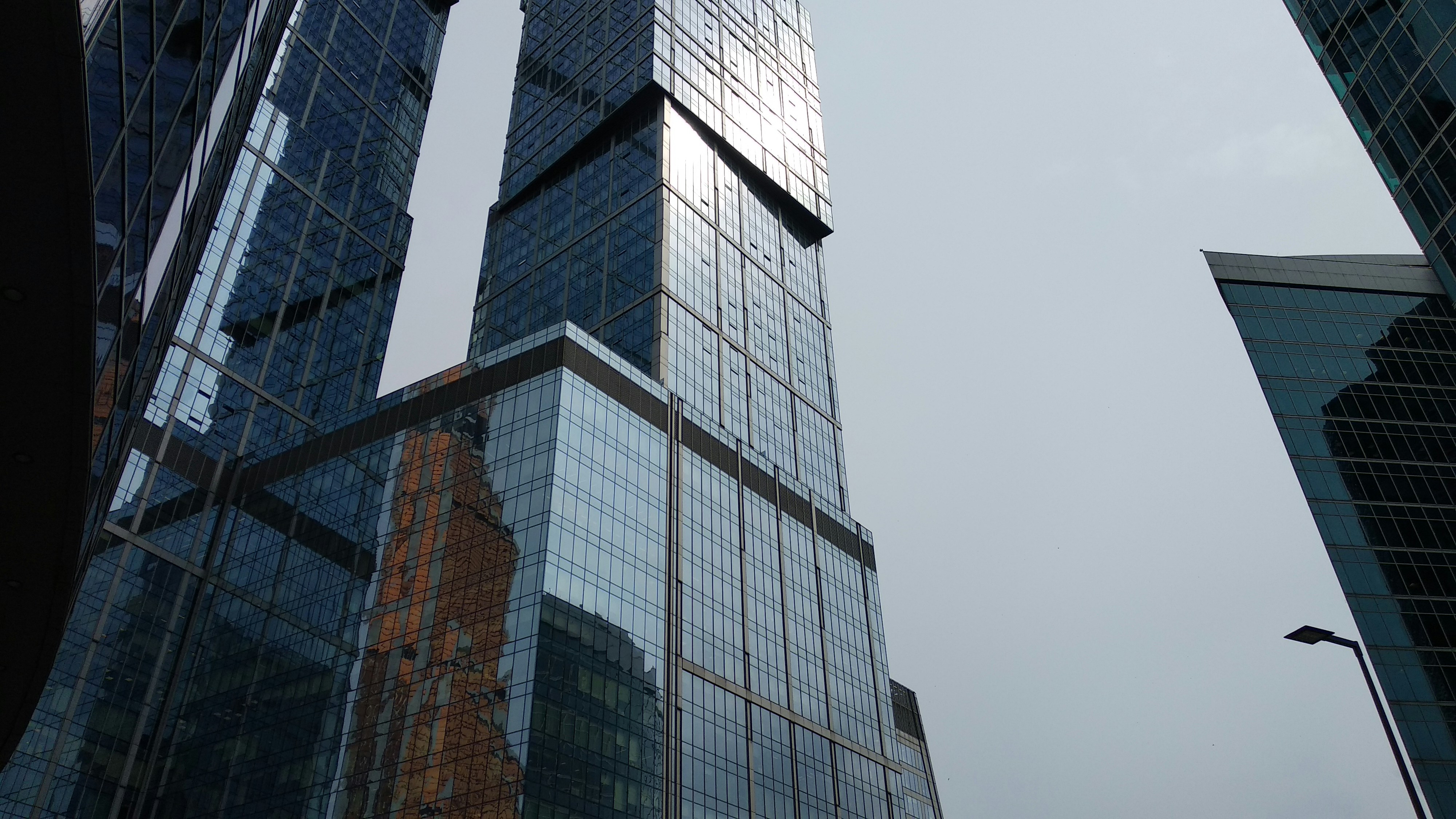 Canyon of Glass: Glass-clad Towers Reaching Toward a Pale Sky
