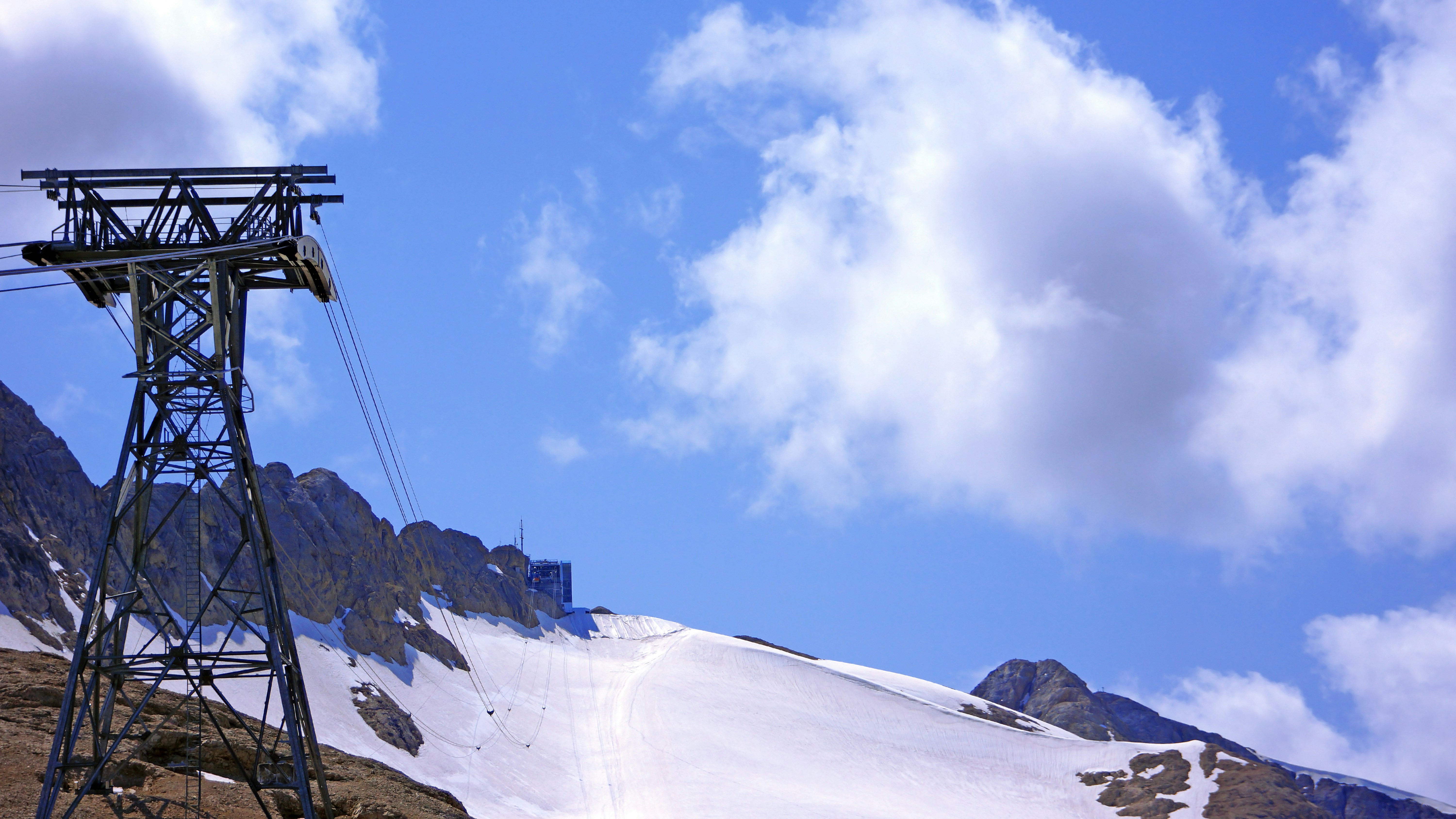 a ski lift going up a snowy mountain