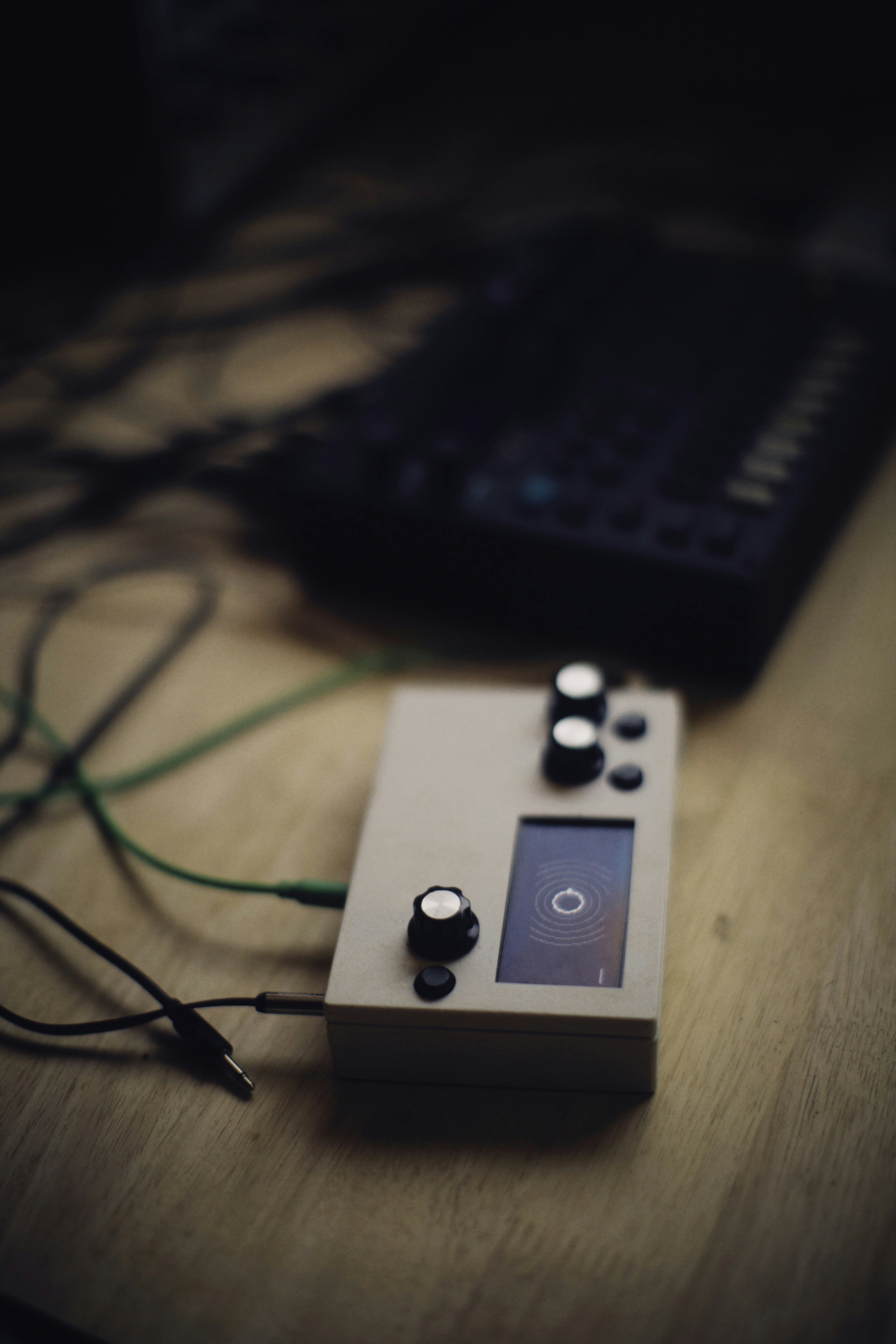 Close-Up Studio Pedal in Low Light: A Glowing Interface on Wood