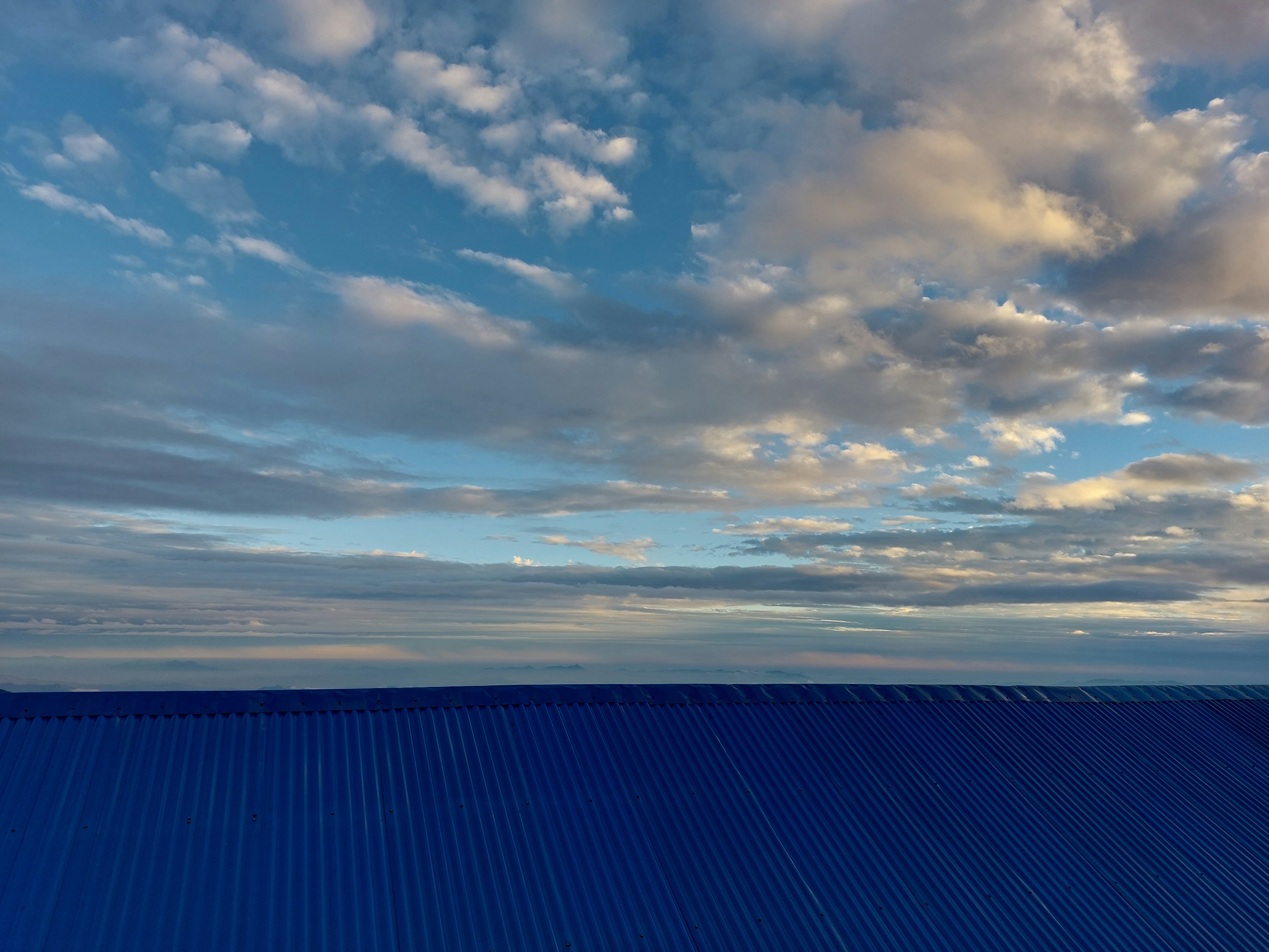 Low Tide Horizon: Clouds Meet the Corrugated Roof