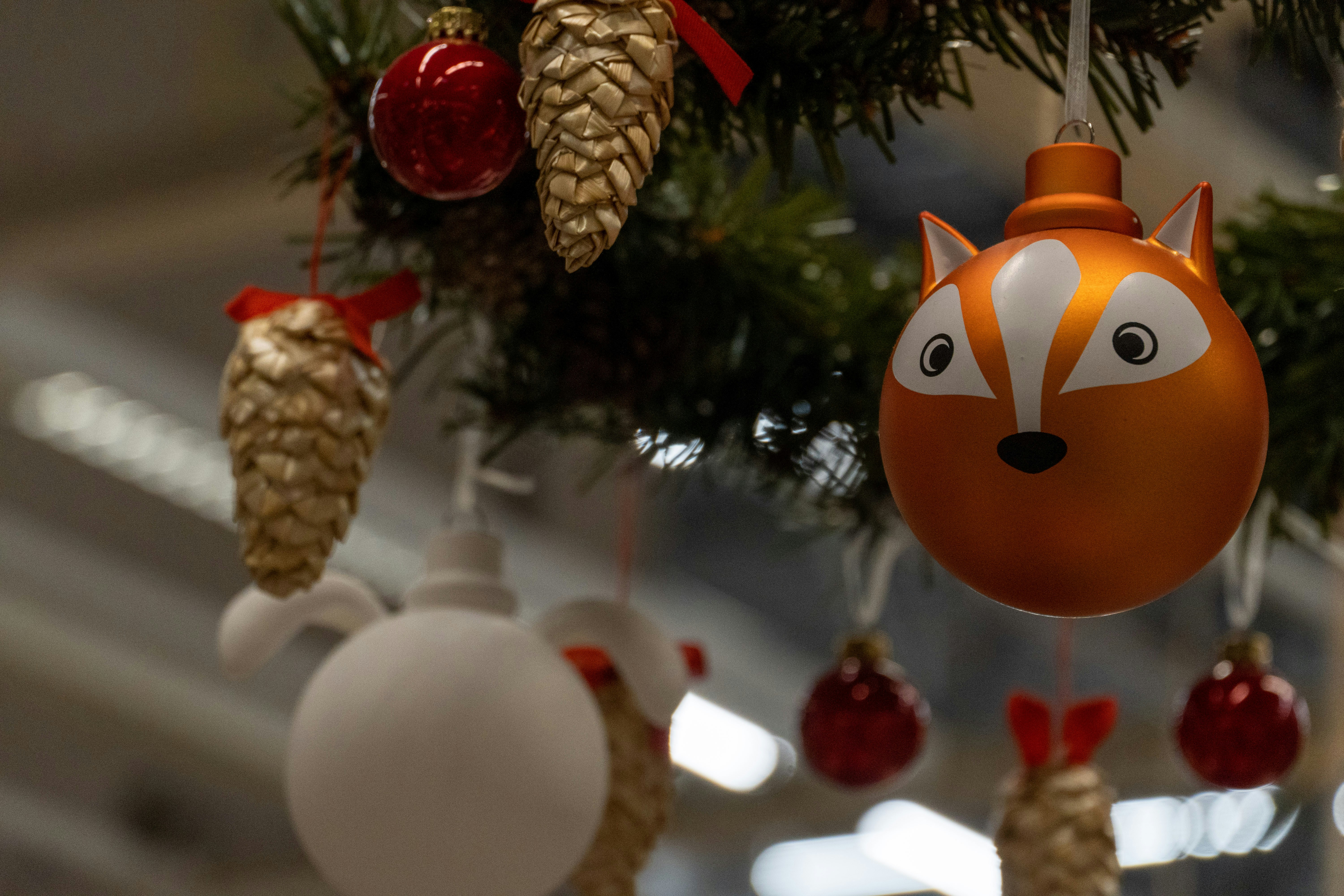Fox Orb Among Pine Cones: A Warm Christmas Tree Moment in Soft Focus