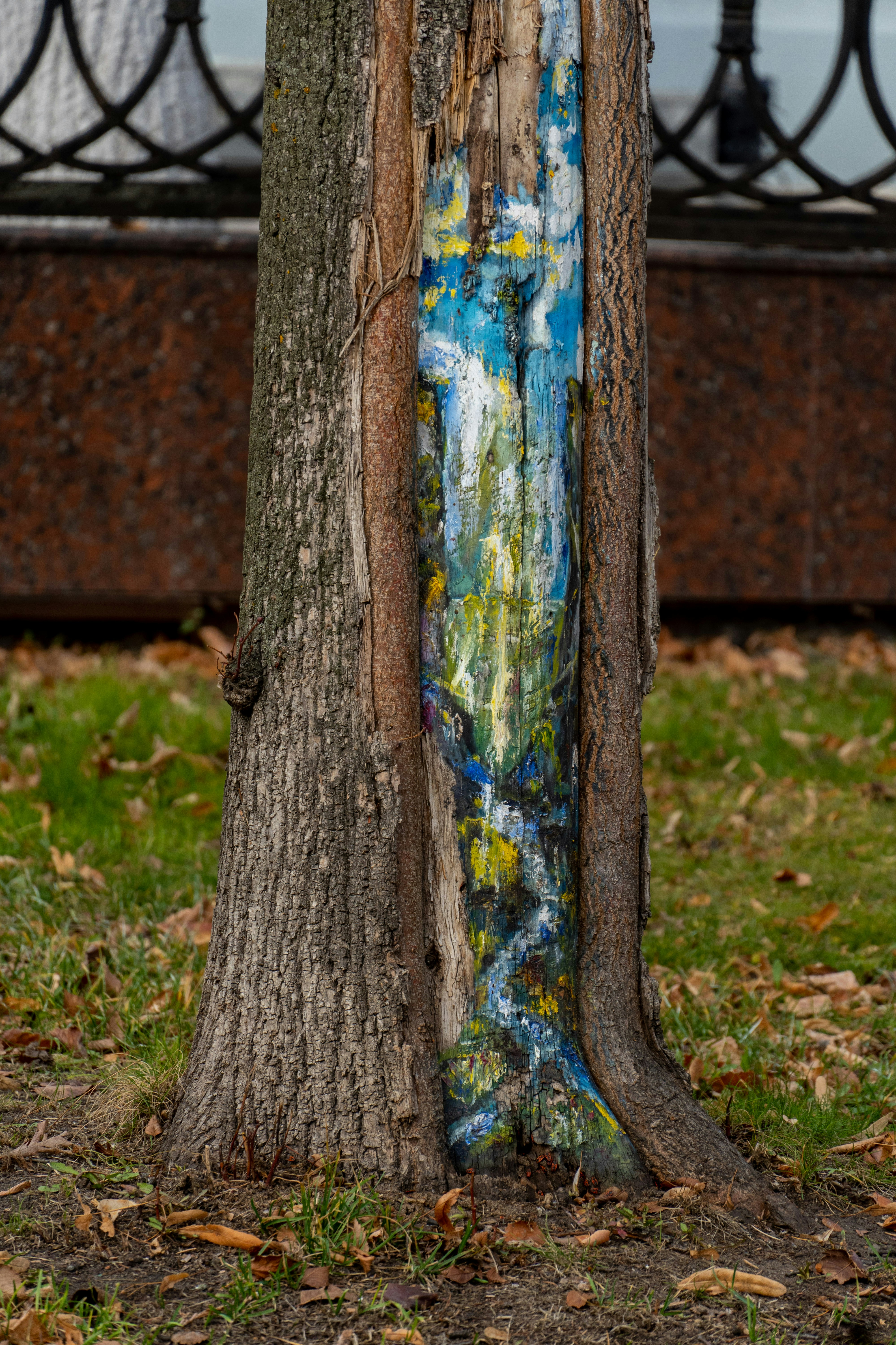 Graffiti Encaustic: Painted Trunk Between Iron Railings