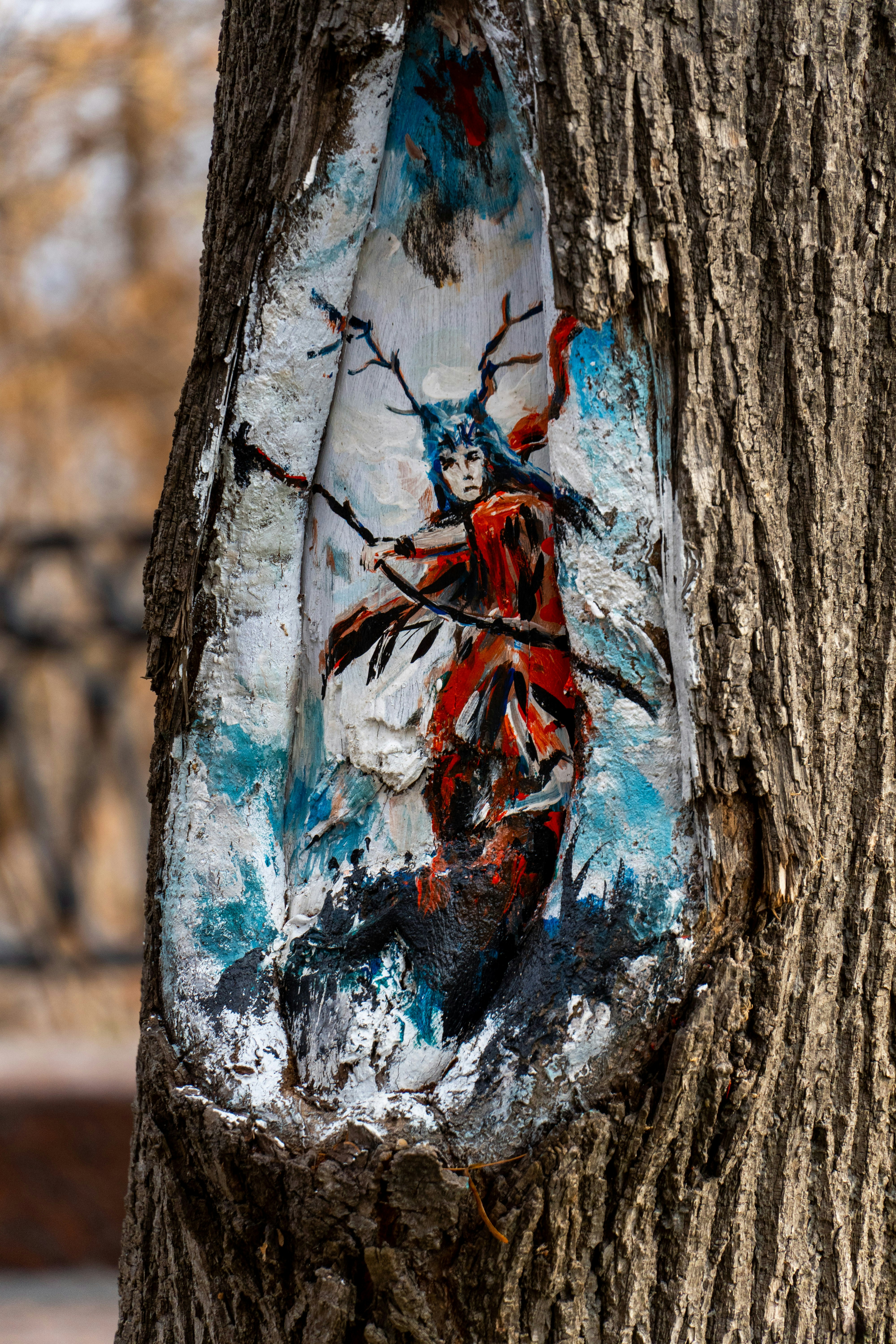 Tree-Borne Warrior: Graffiti Portrait in a Trunk