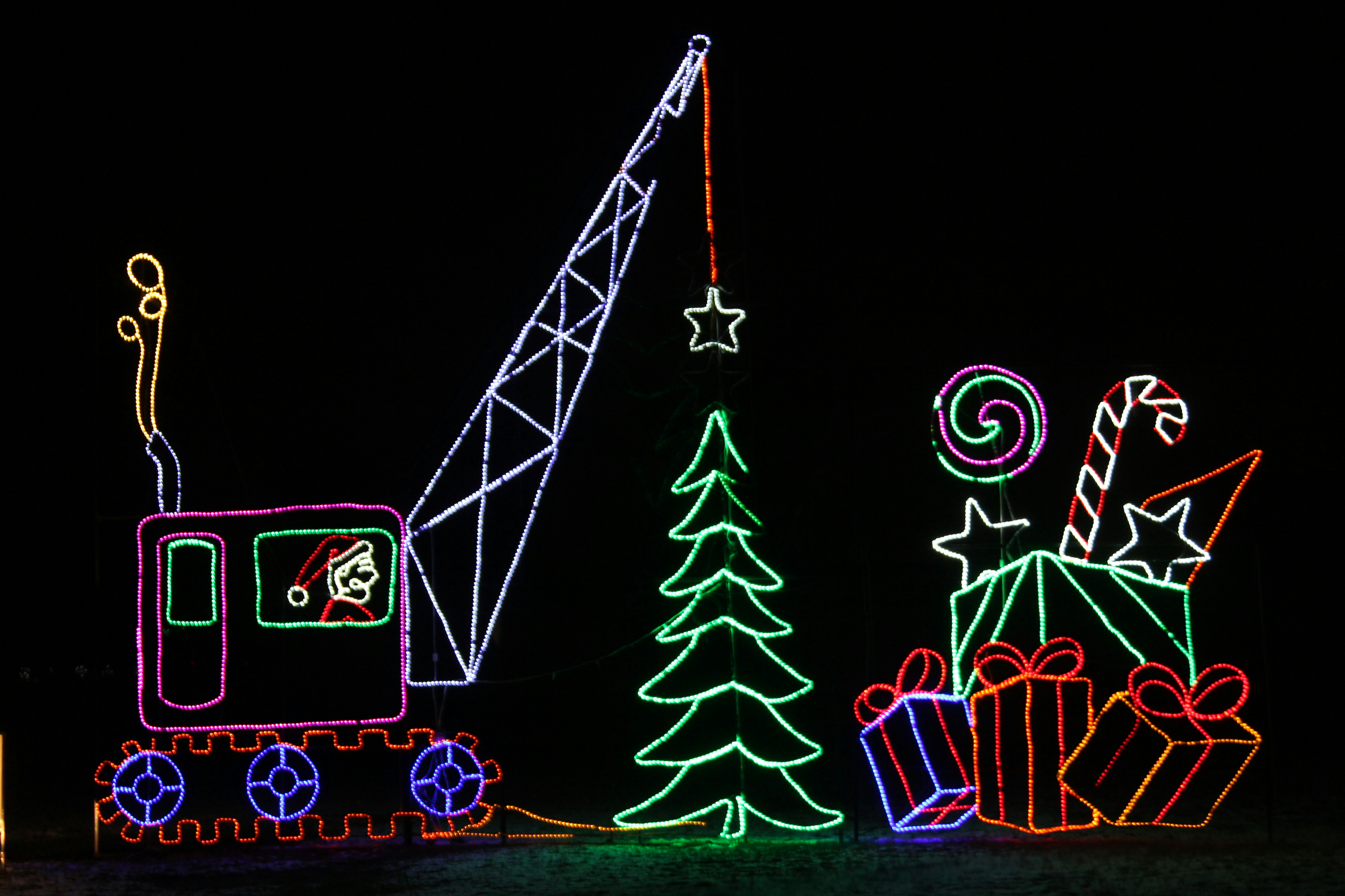 Crane of Light and Gifts: Nighttime Holiday Steel