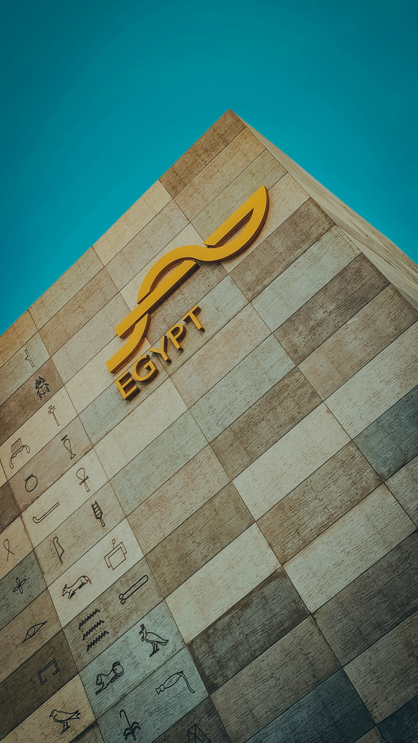 The egyptian symbols are on the wall of the building photo – Free Blue ...