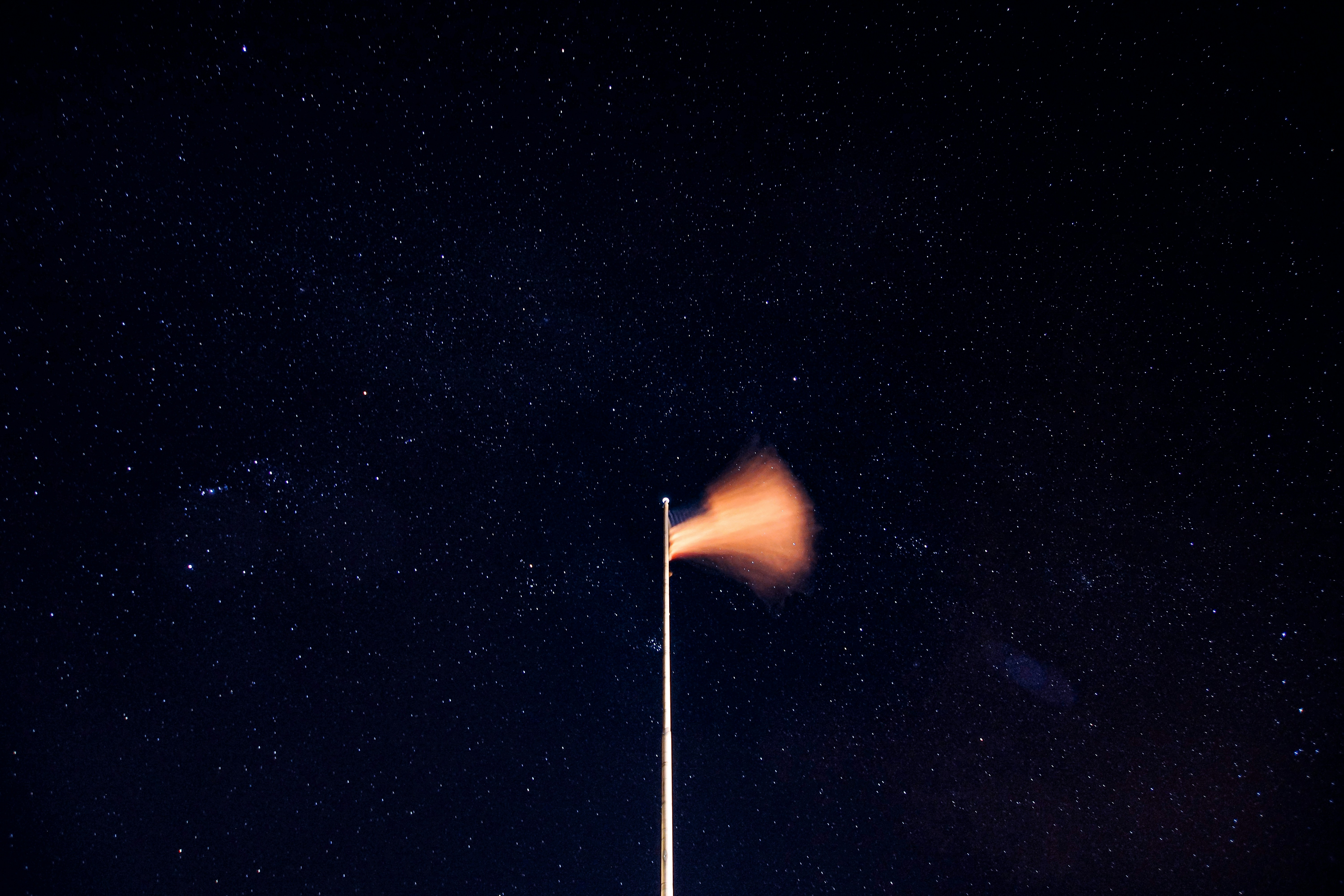 Long-Exposure Beacon Against a Star-Scattered Night Sky