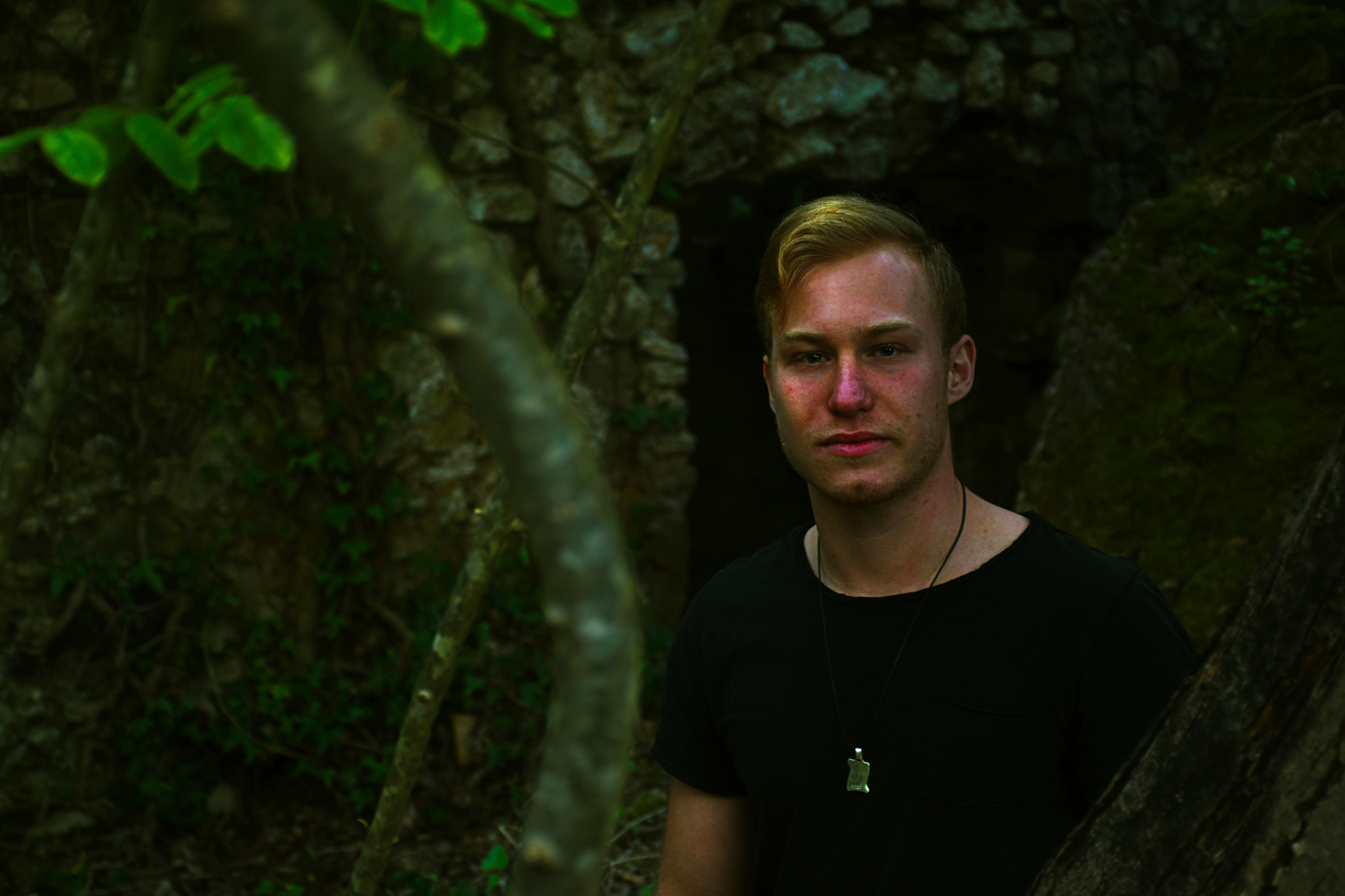 Portrait in a Shadowed Stone Grotto