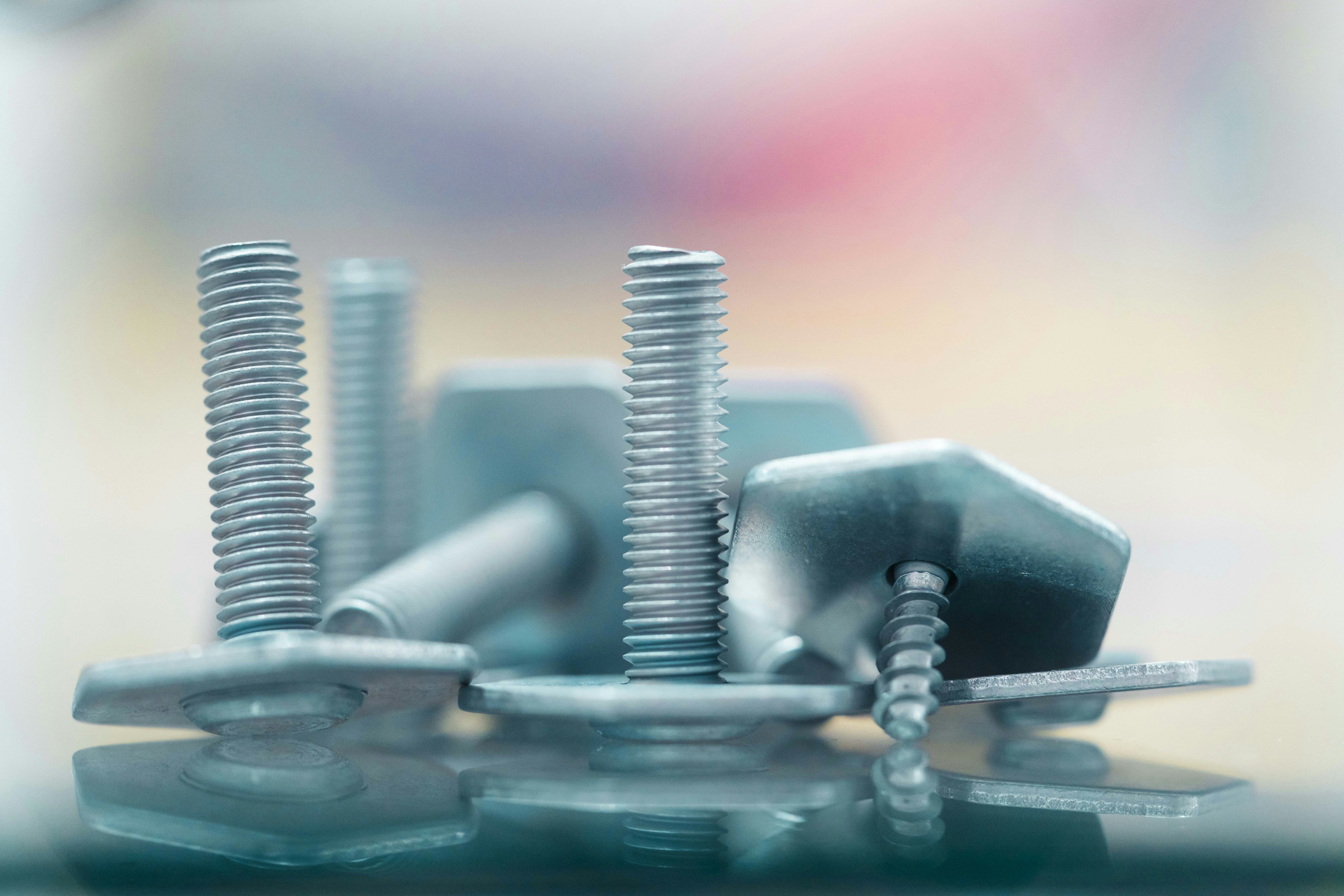 Teal-Gloss Macro: A Focused Bolt Anchoring a Tiny Hardware Still Life