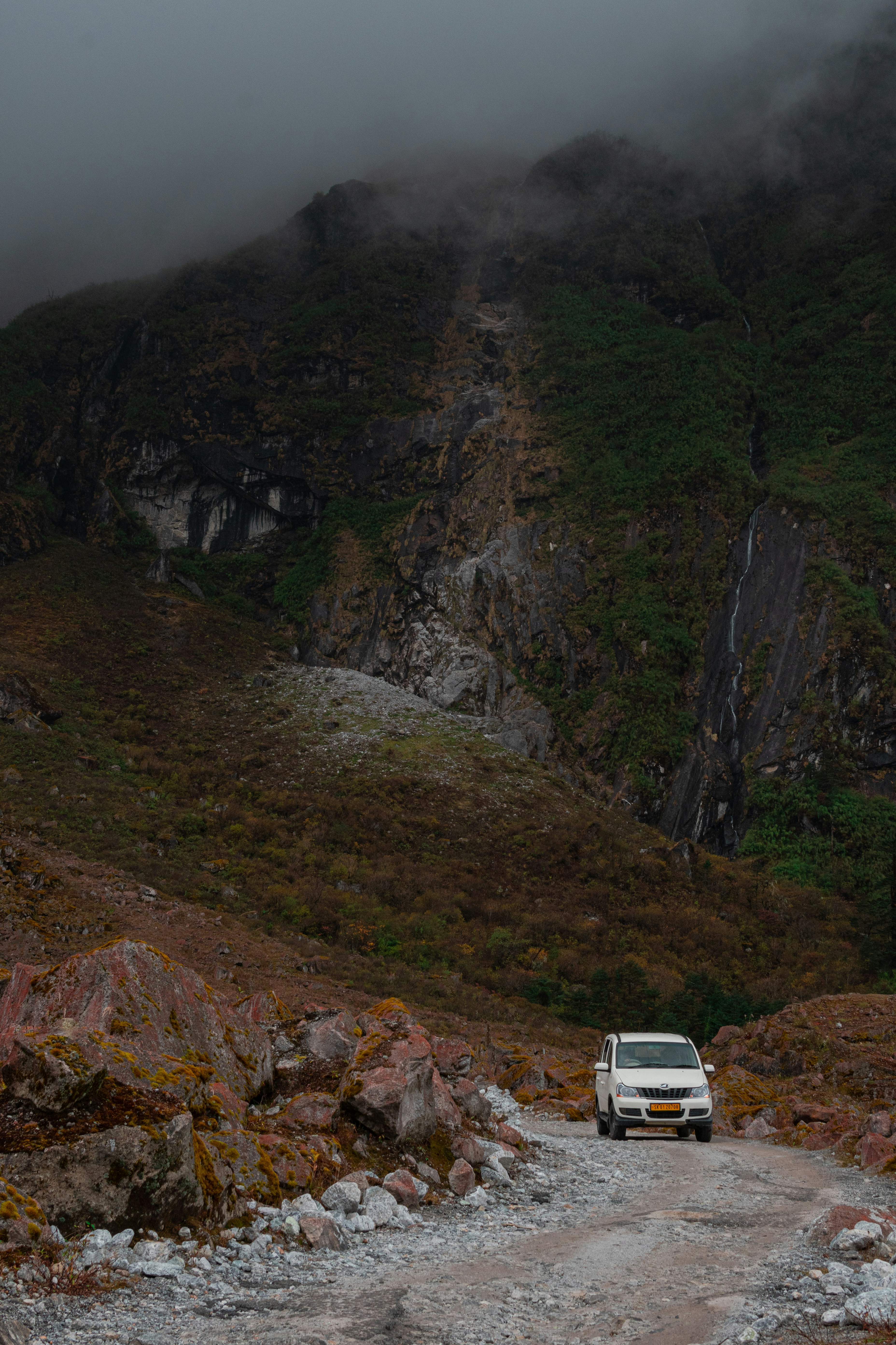 a white truck driving down a dirt road