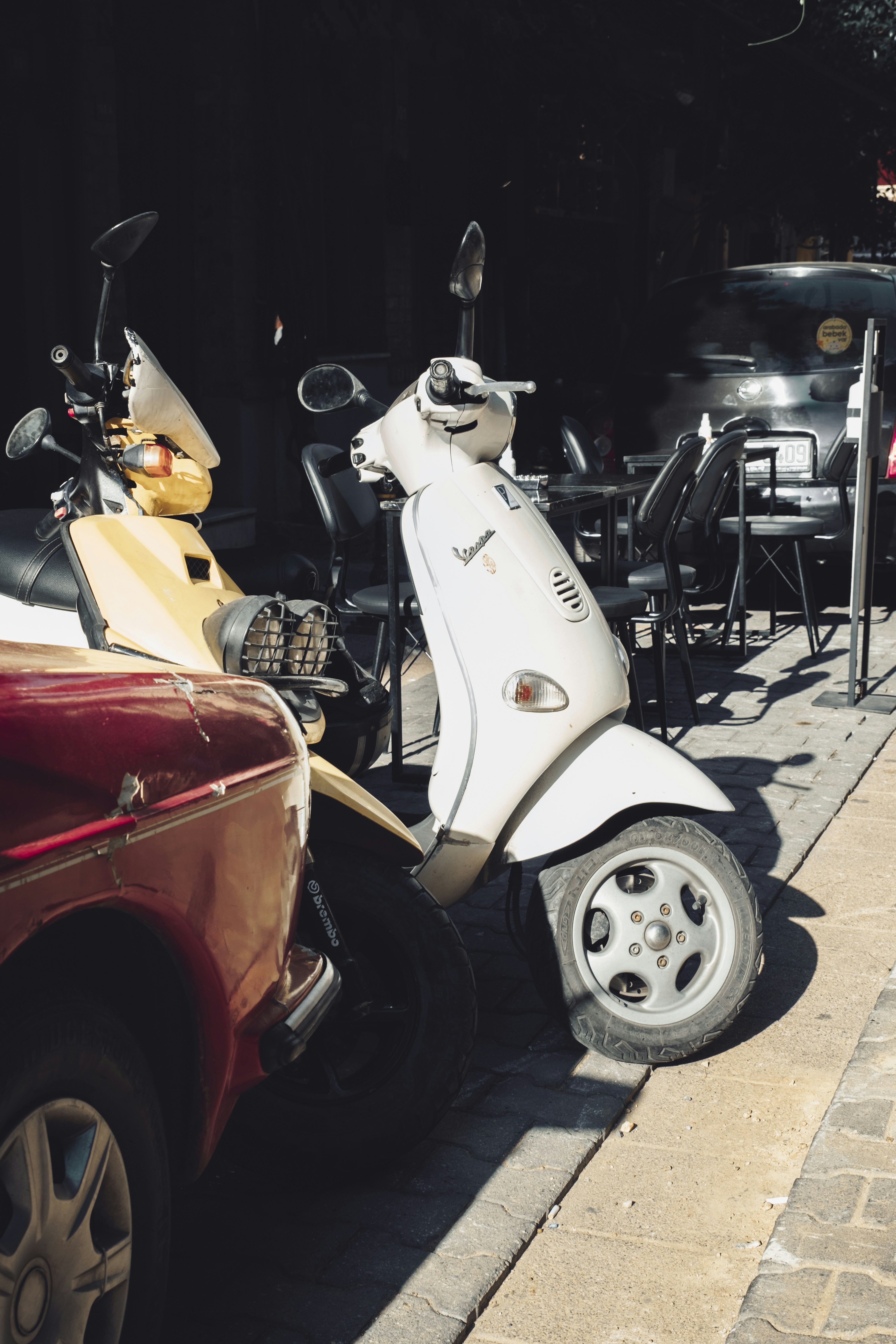 White Vespa at the Edge of Light: Street-Side Scooters in Shade