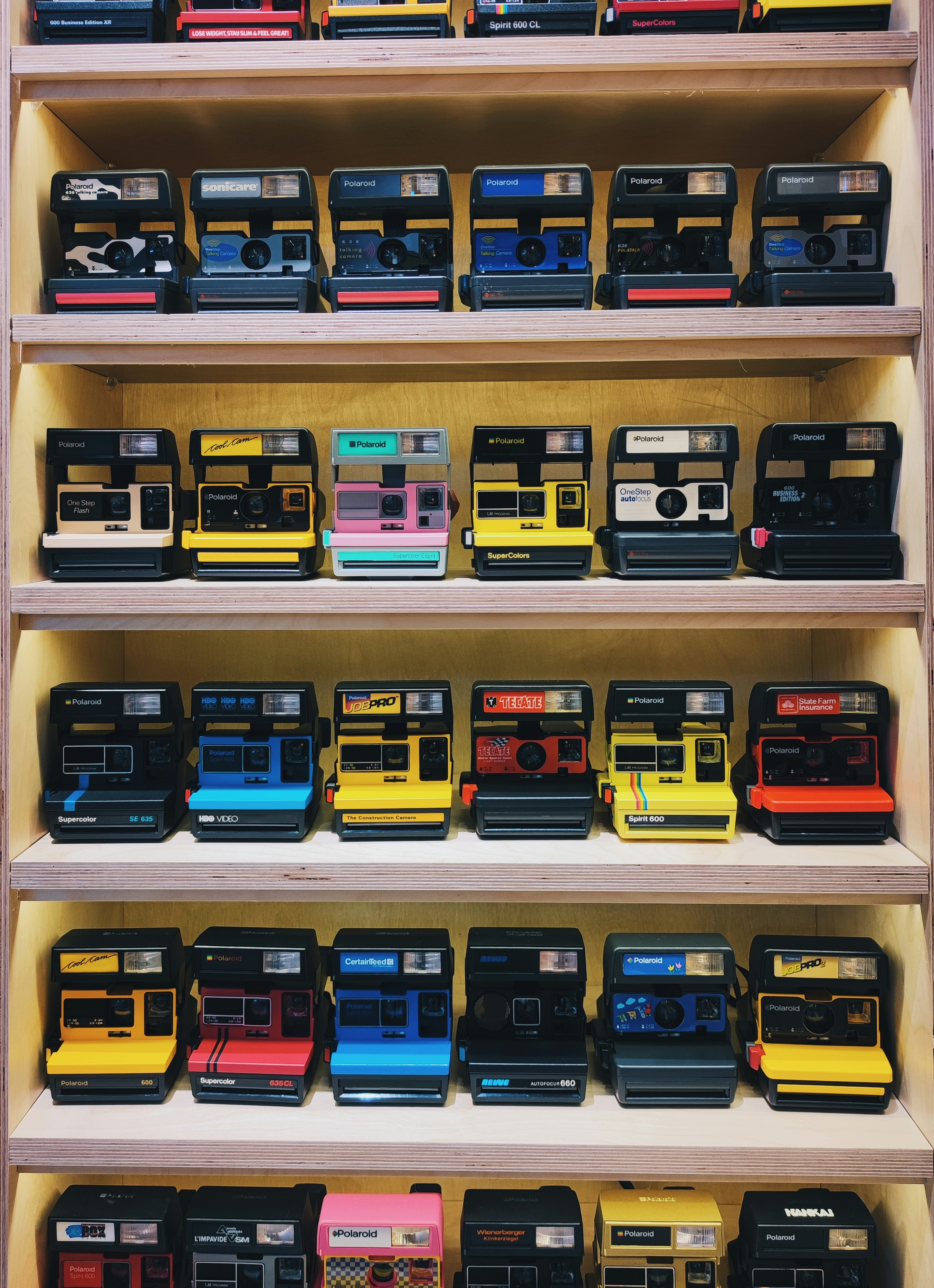 A shelf filled with lots of different types of electronic devices photo ...