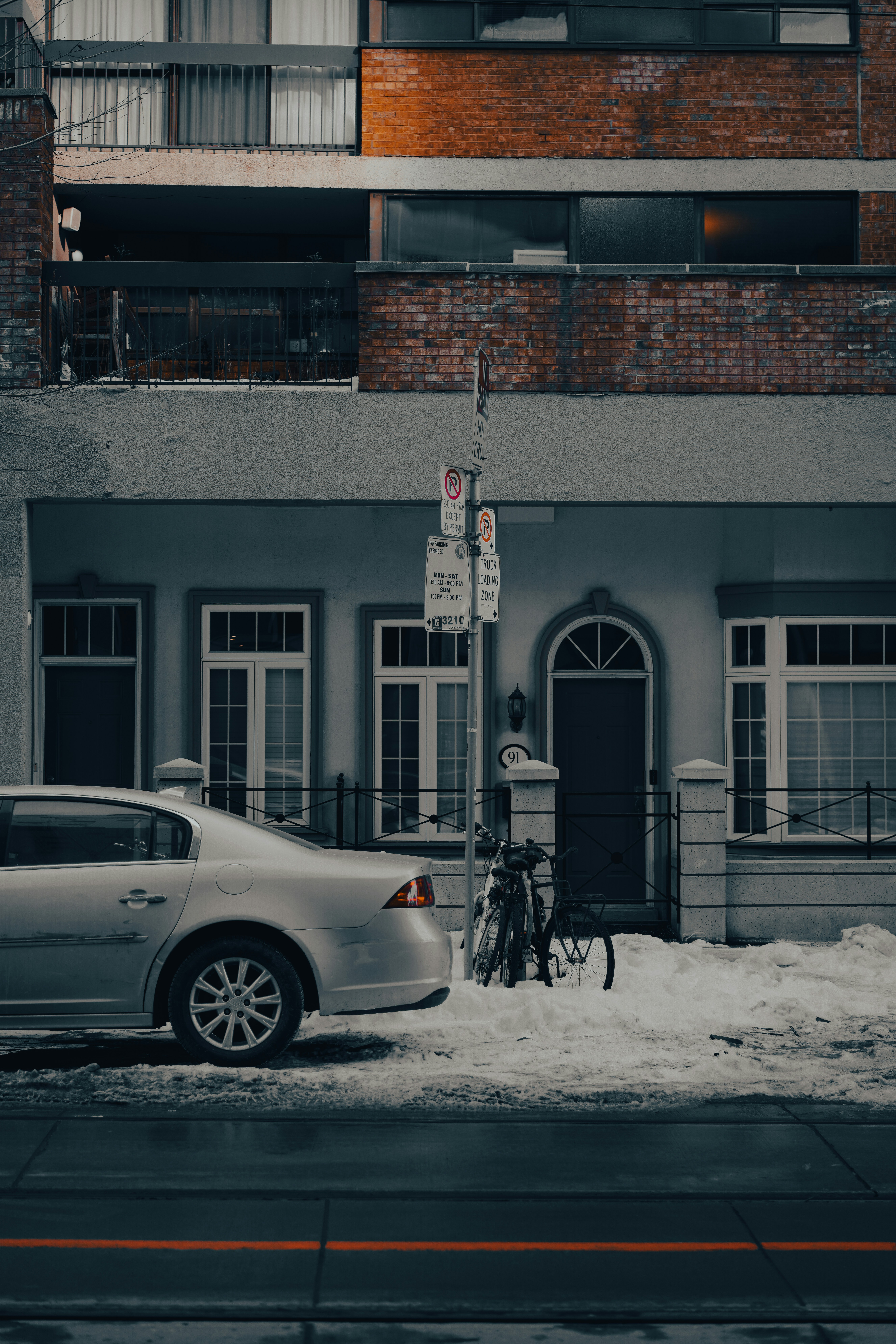 Snow-Quiet Streetfront: Bicycle by the Blue Townhouse