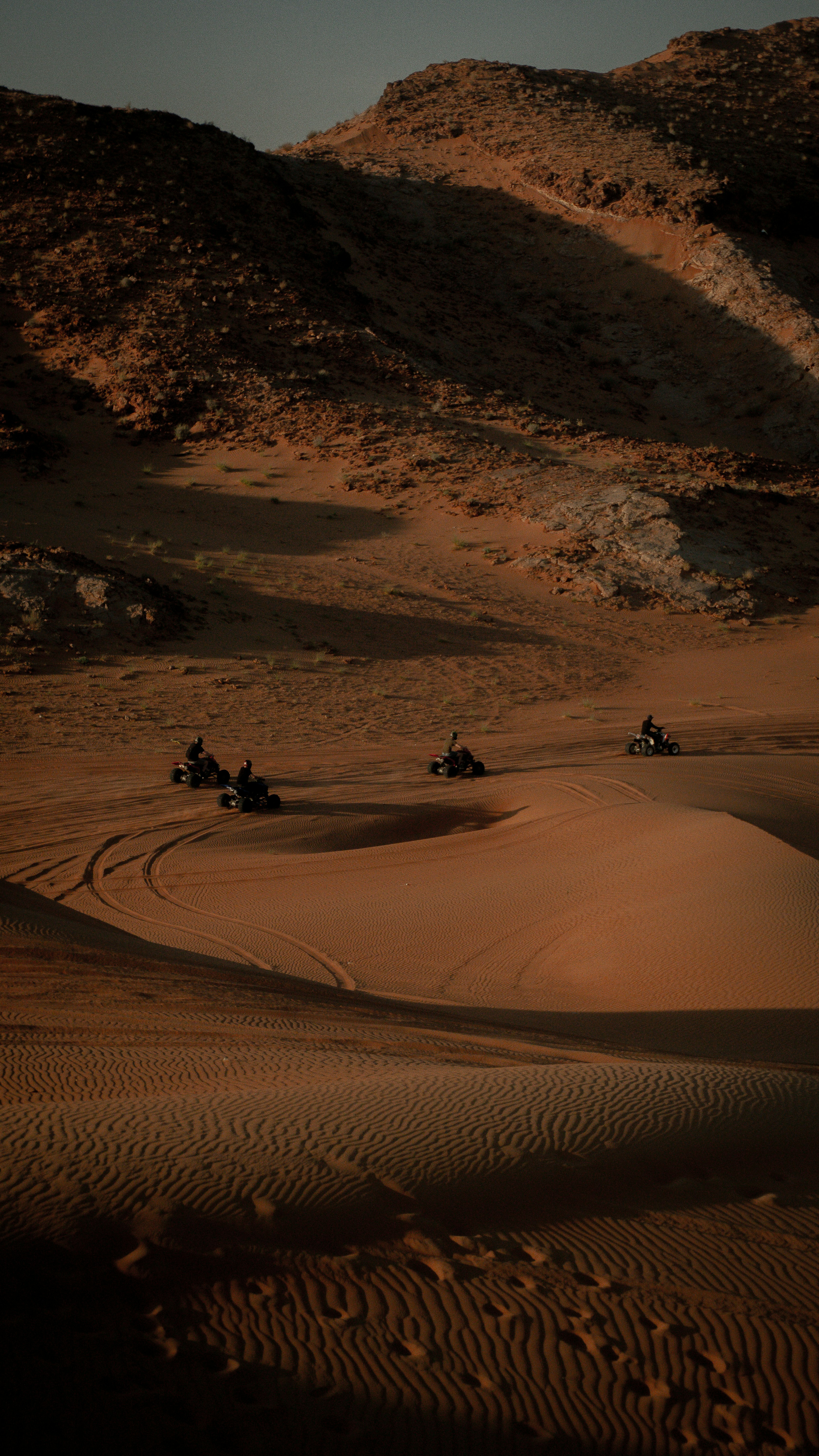 A group of four people riding four wheelers in the desert photo – Free ...