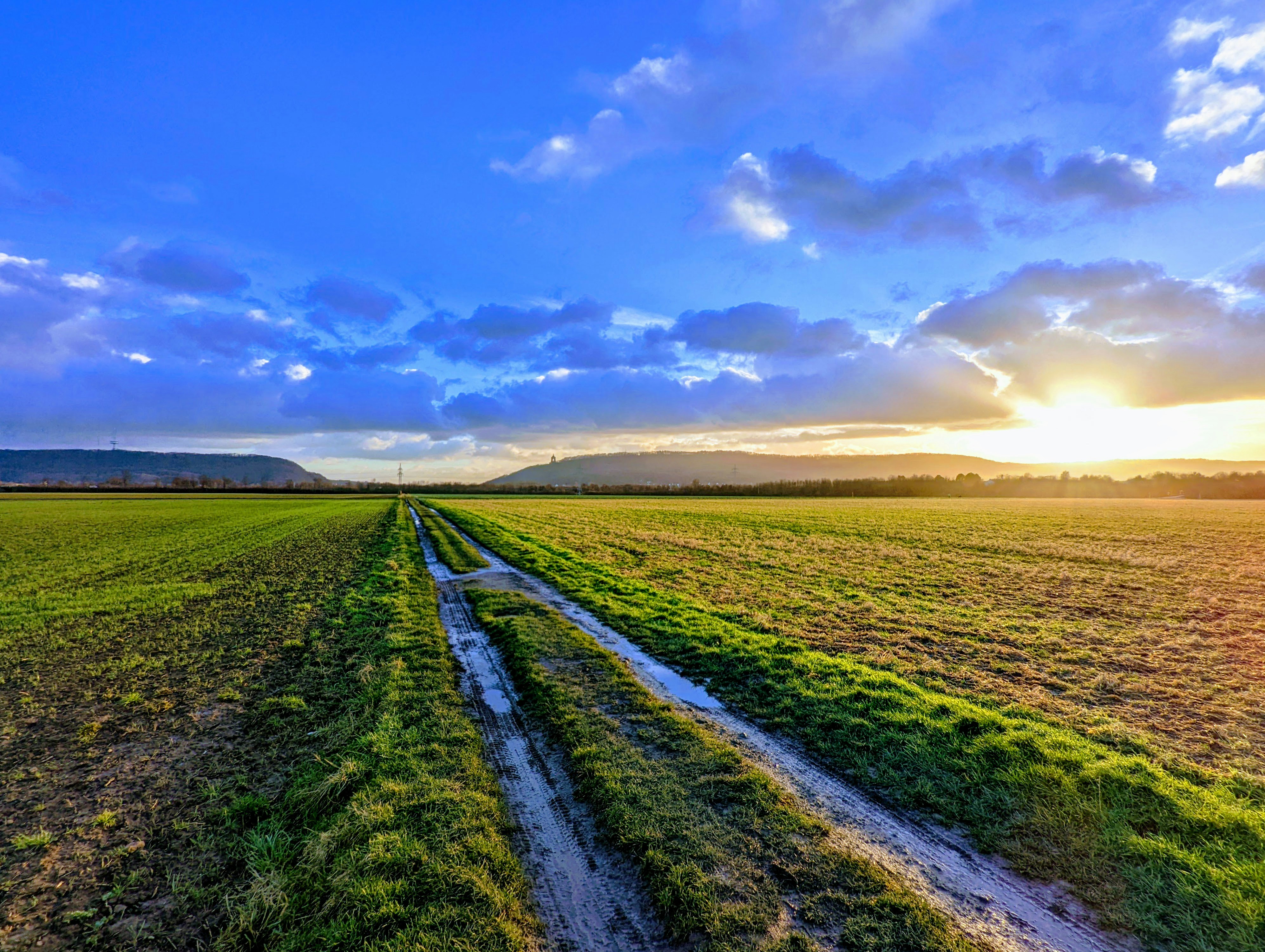 The sun is setting over a large field photo – Free Porta westfalica ...