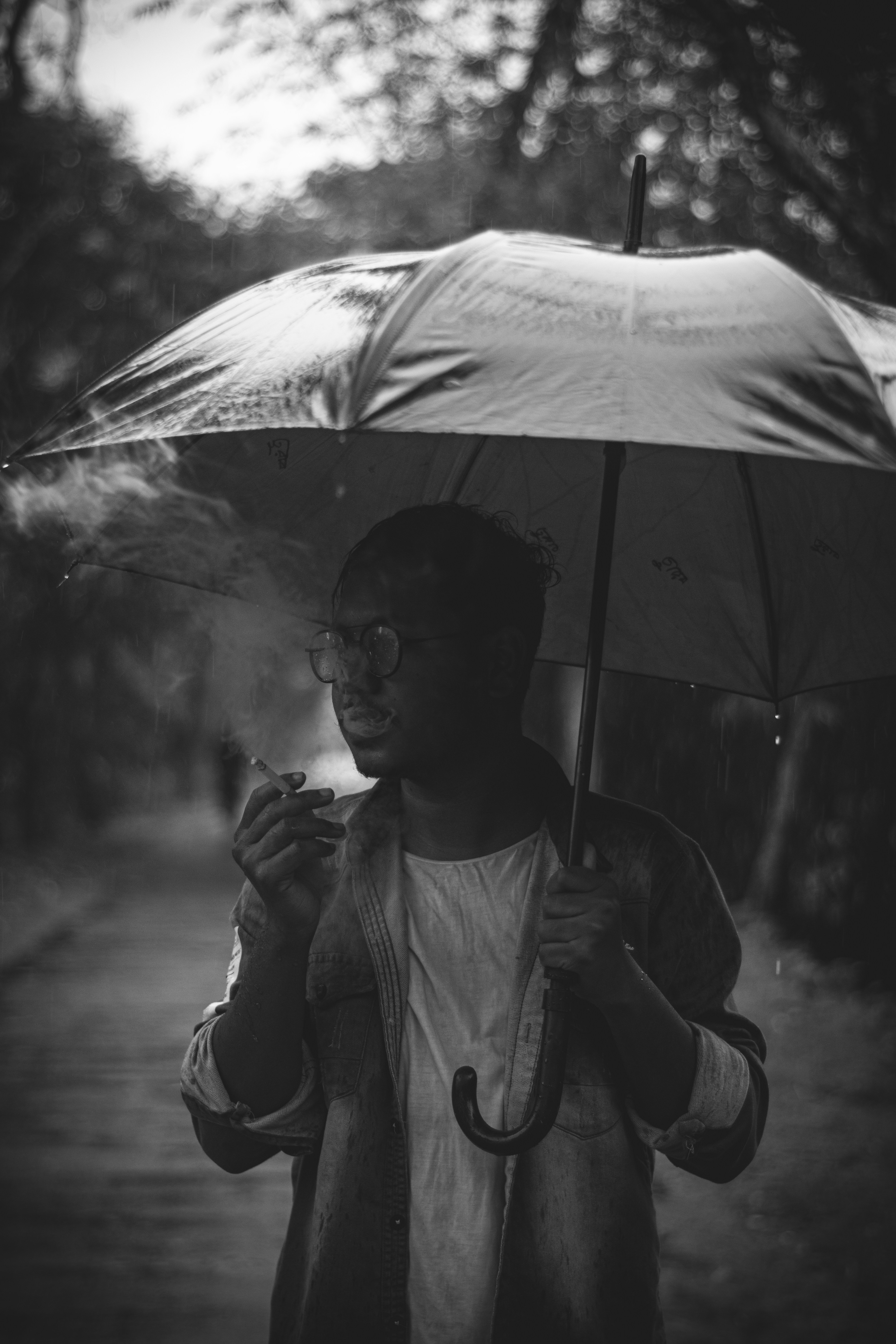 Monochrome Rain: A Solitary Figure Under an Umbrella