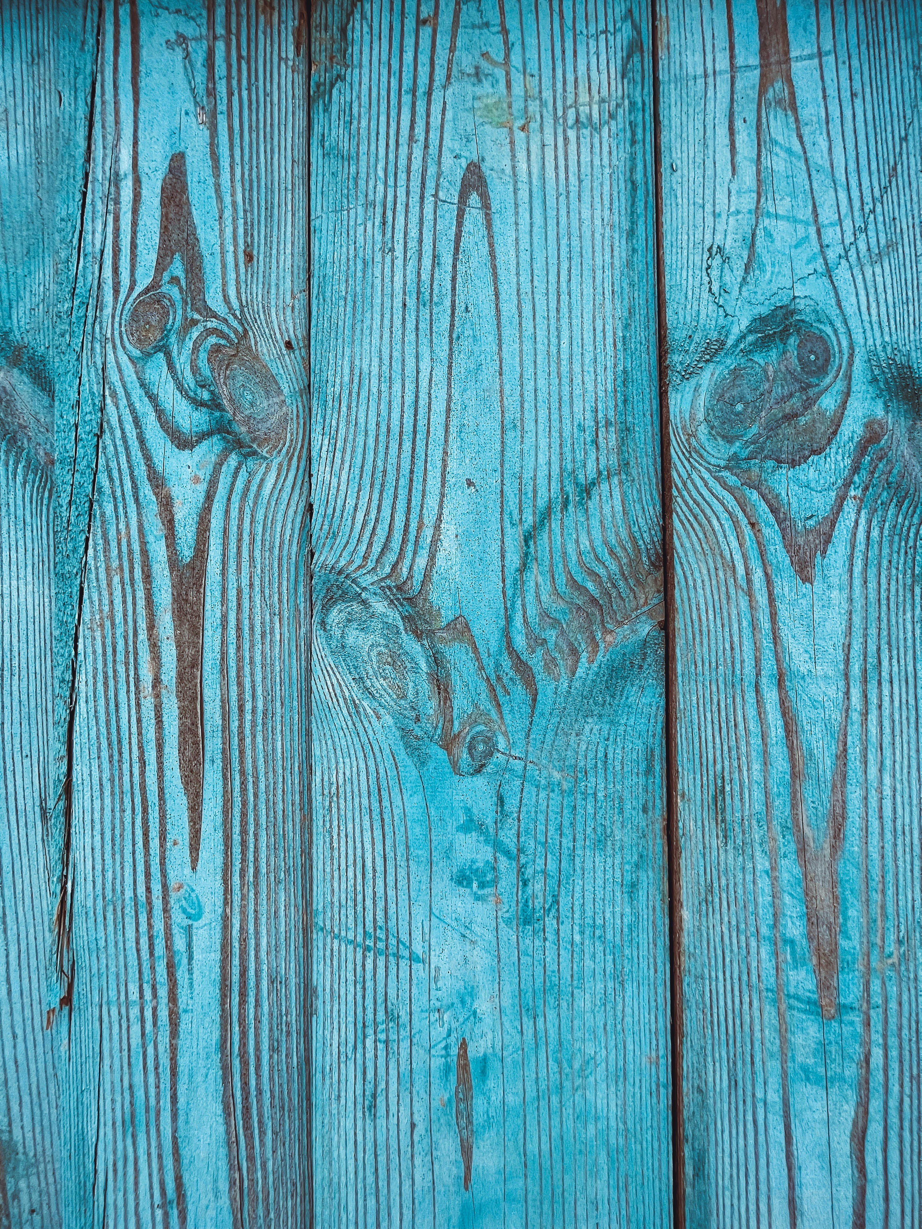 a close up of a wooden surface with peeling paint