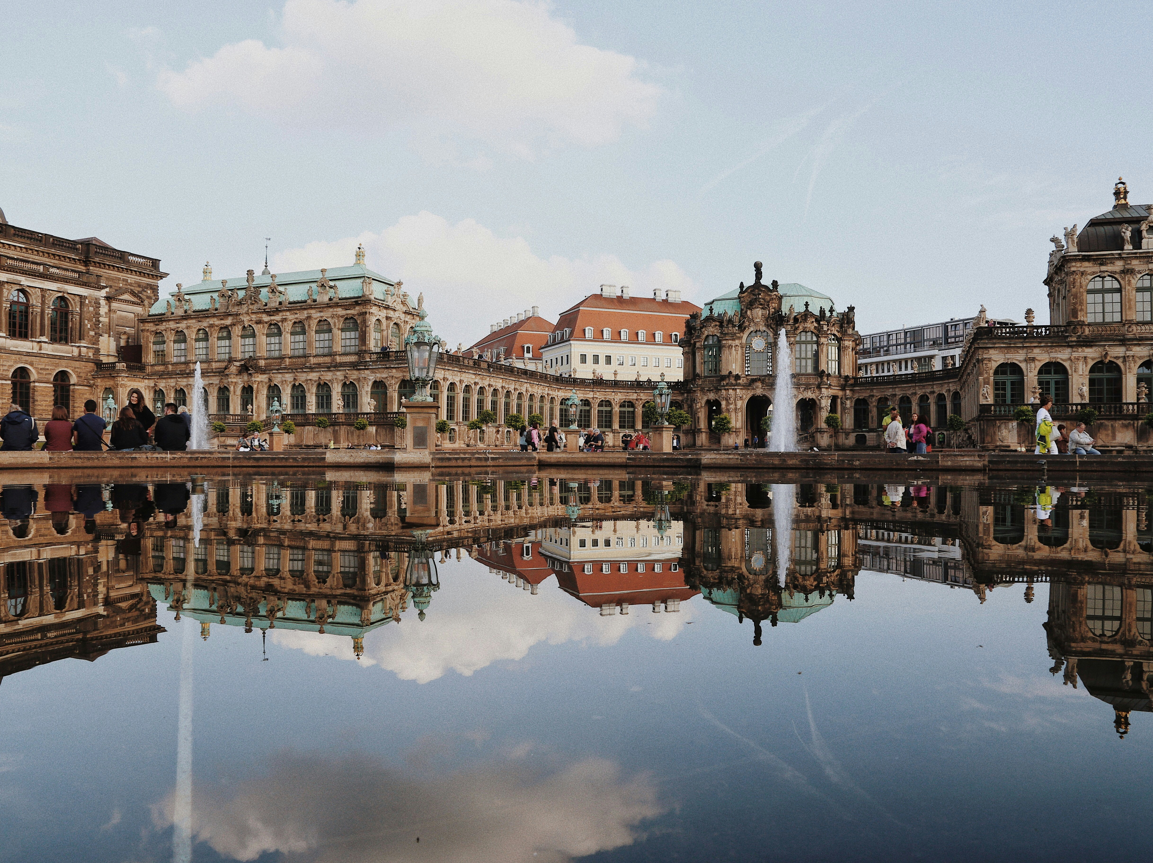 Historic buildings along a serene waterway, showcasing intricate architecture and vibrant reflections in the water.