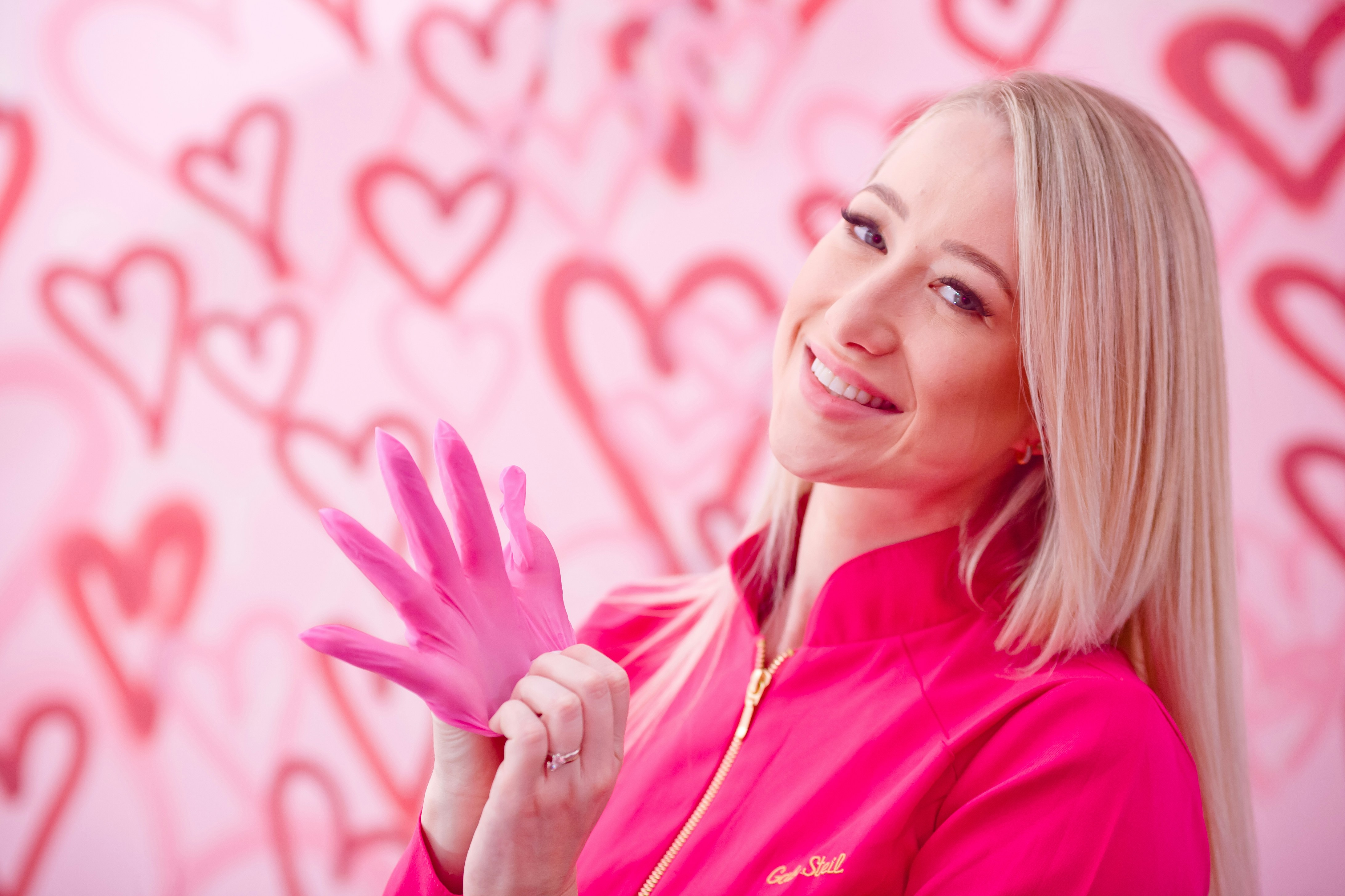 Heartfelt Smile Under Pink Backdrop