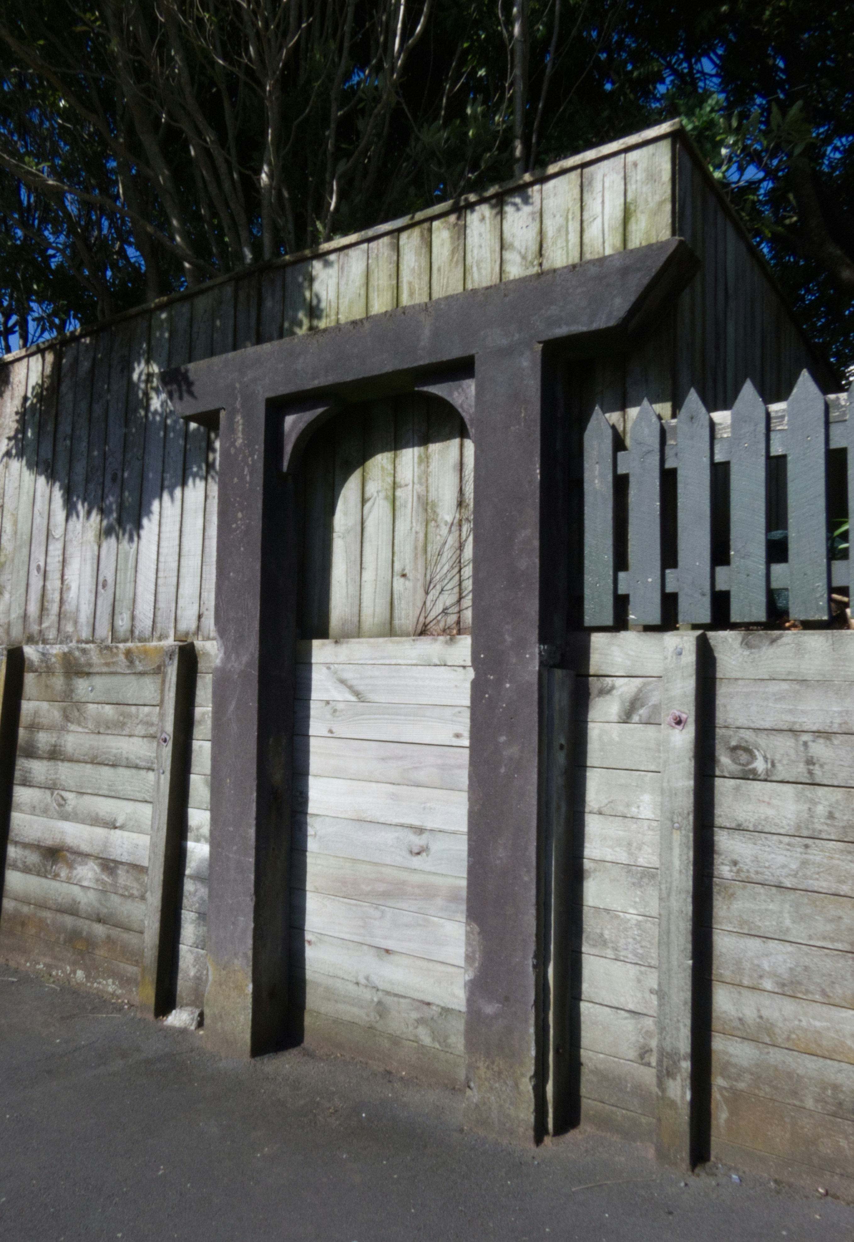 Weathered Gateway: A Quiet Dawn at the Wooden Fence Arch