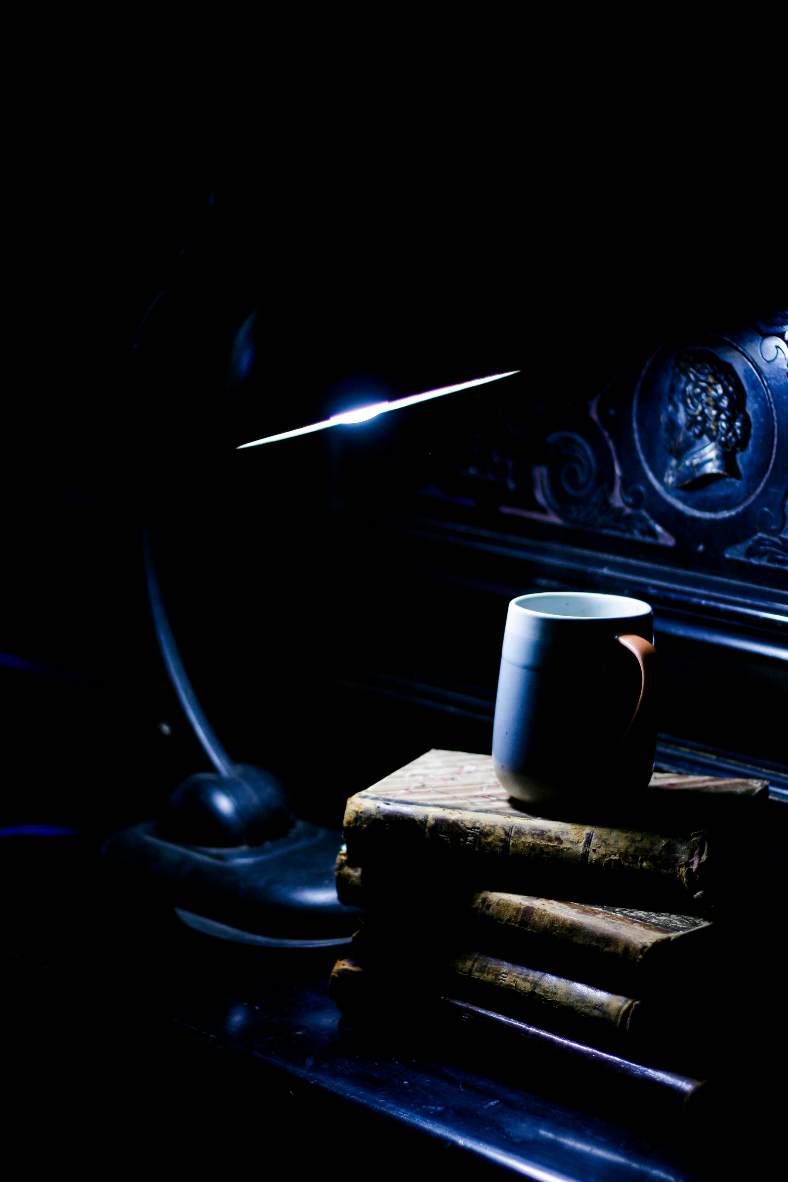 Blue Hour Brew: Mug Resting on Weathered Blocks Beneath a Narrow Neon Sliver