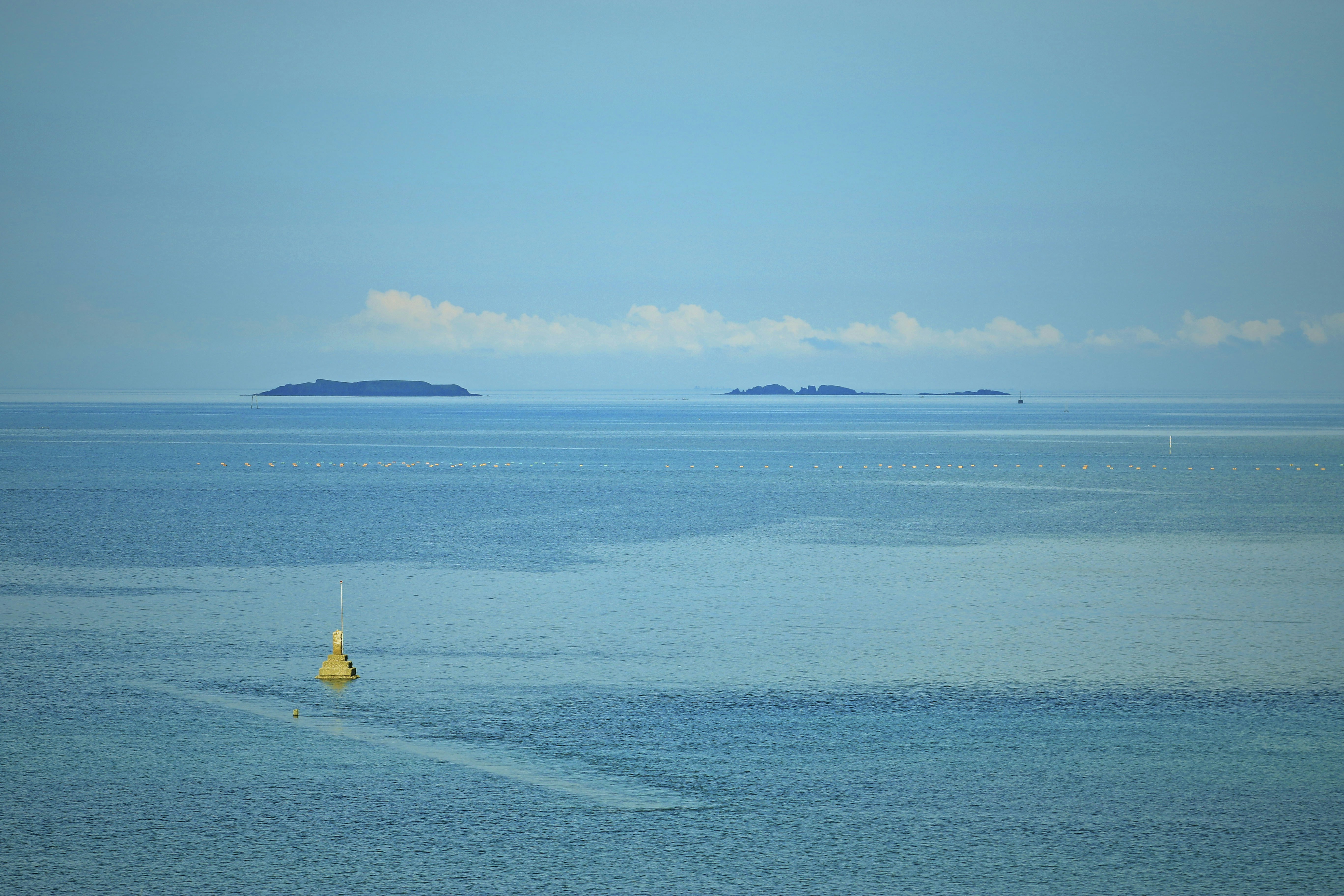 A yellow buoy floating in the middle of a large body of water photo ...