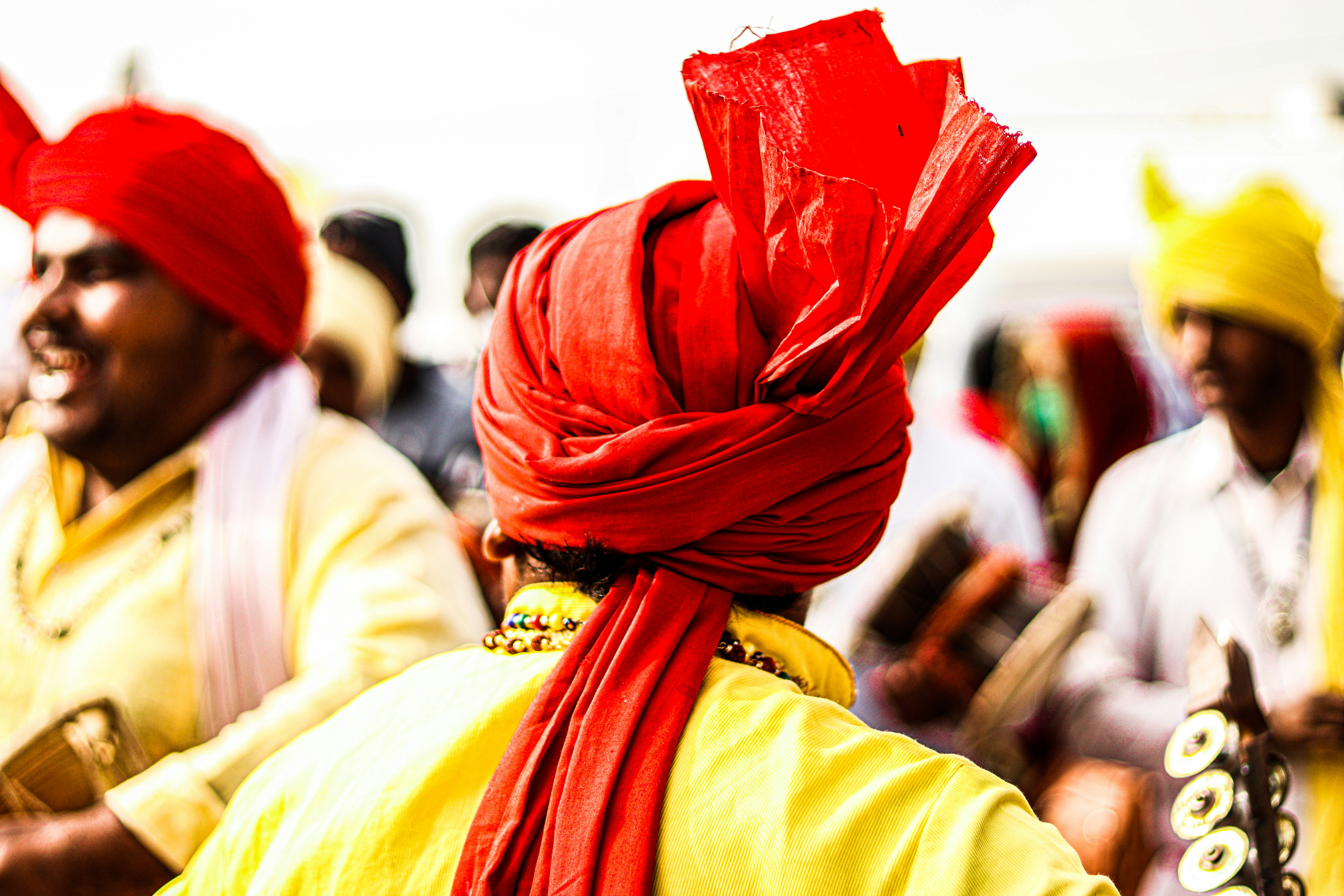 A group of men in yellow and red turbans photo – Free Clothing Image on ...