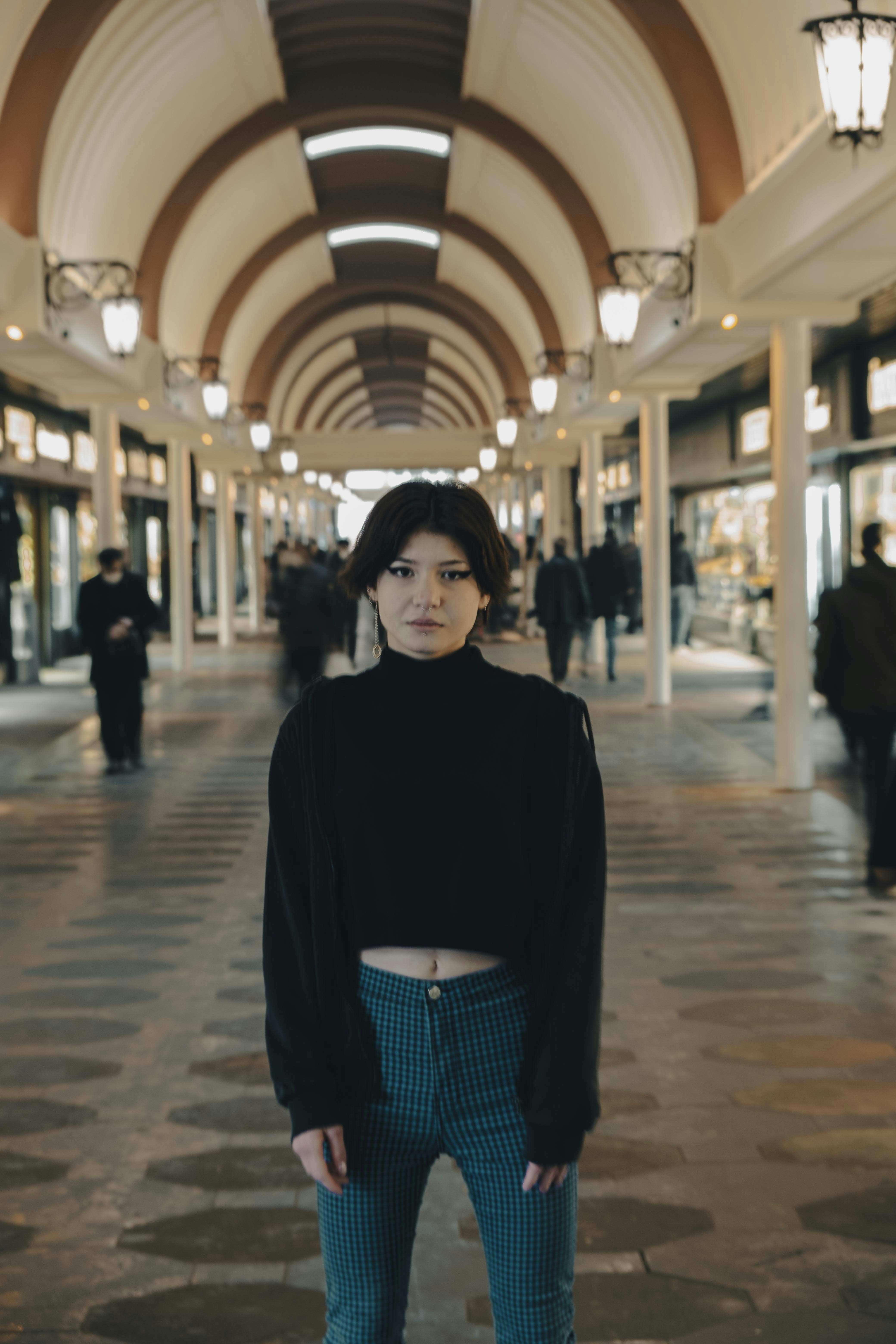 a woman is standing in a large building