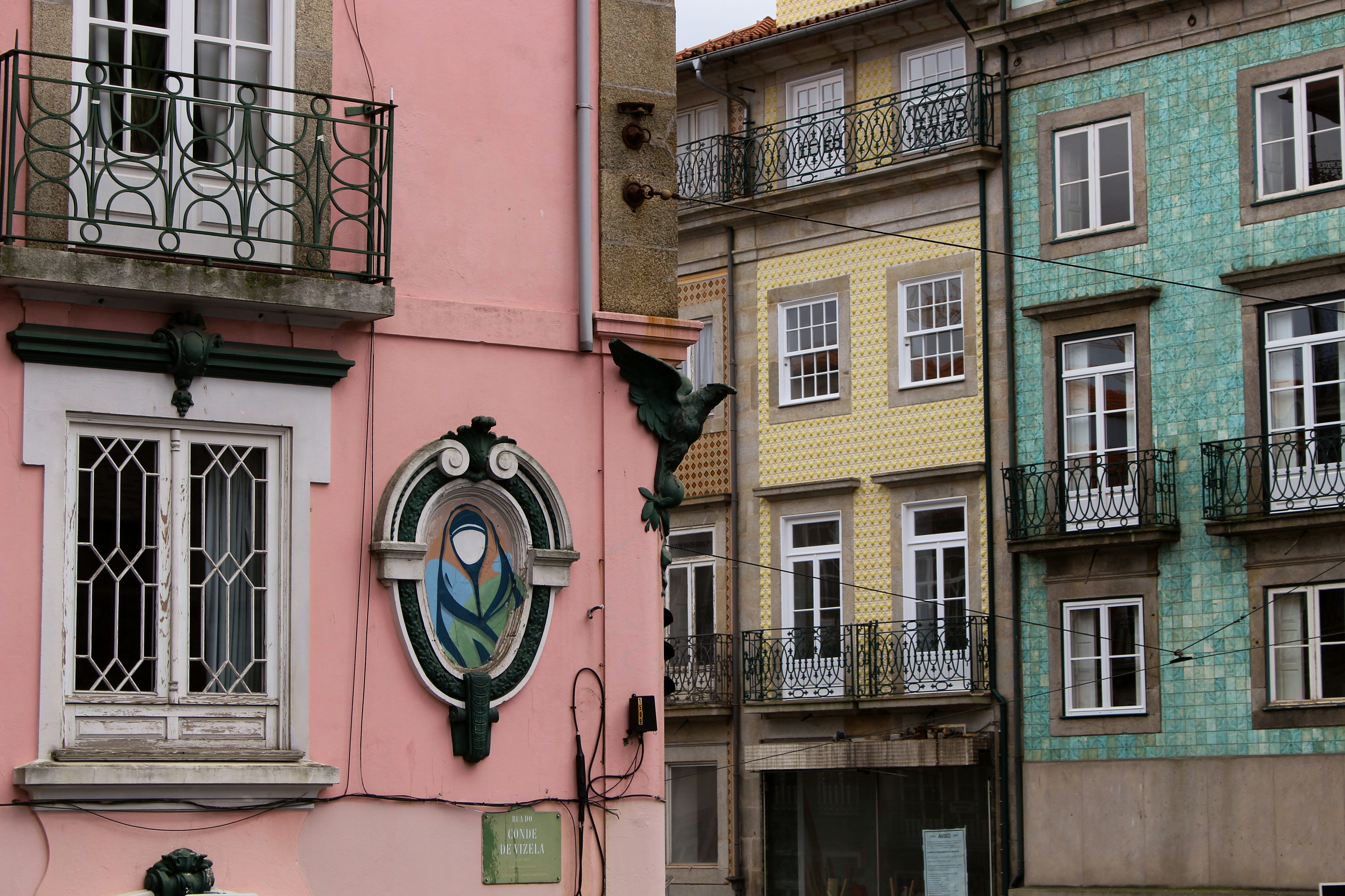 Pastel Roundel on a Pink Facade: A Colorful Street Corner