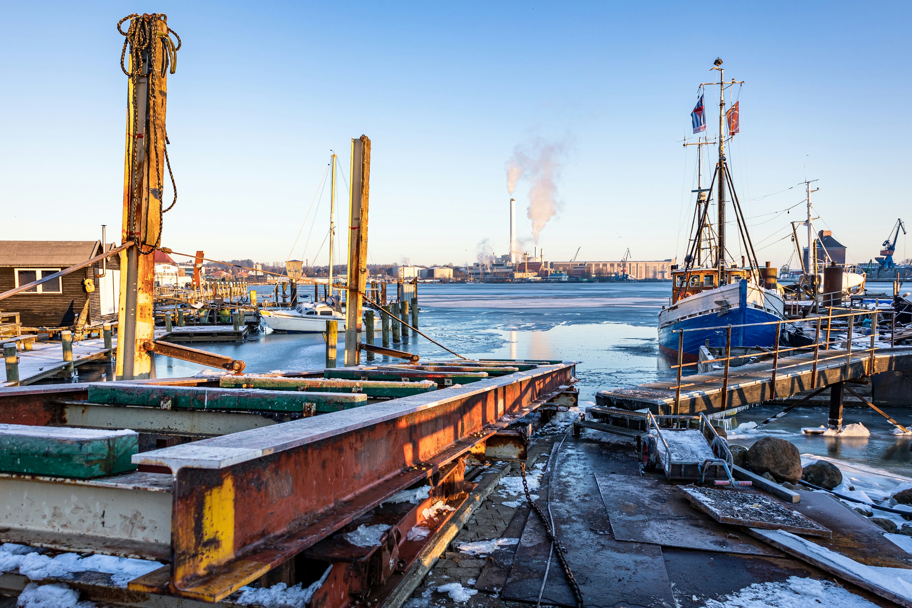 A harbor filled with lots of boats on top of snow covered ground photo ...