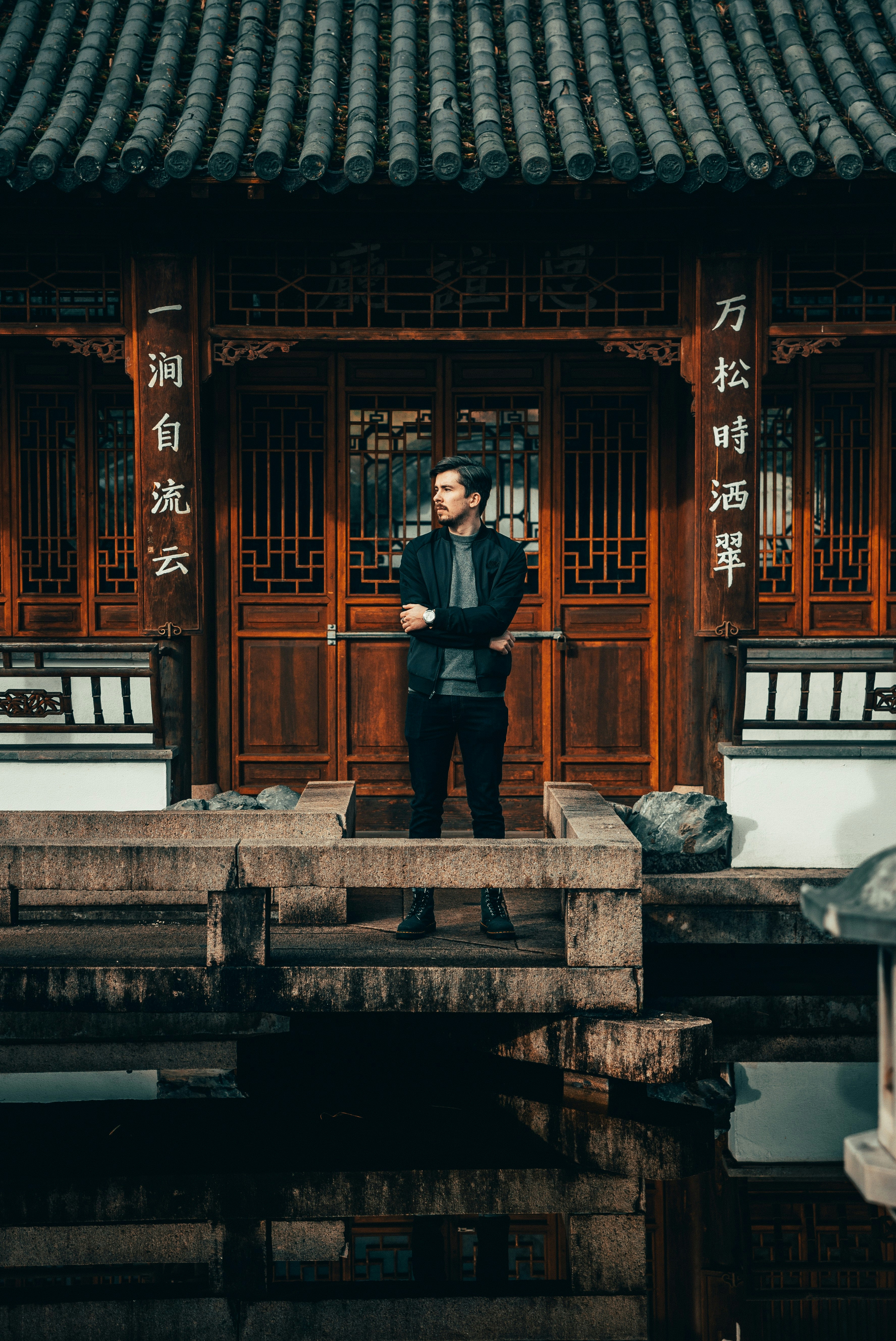Centerstage at the Lantern Pavilion: a solitary figure framed by a Chinese riverside doorway