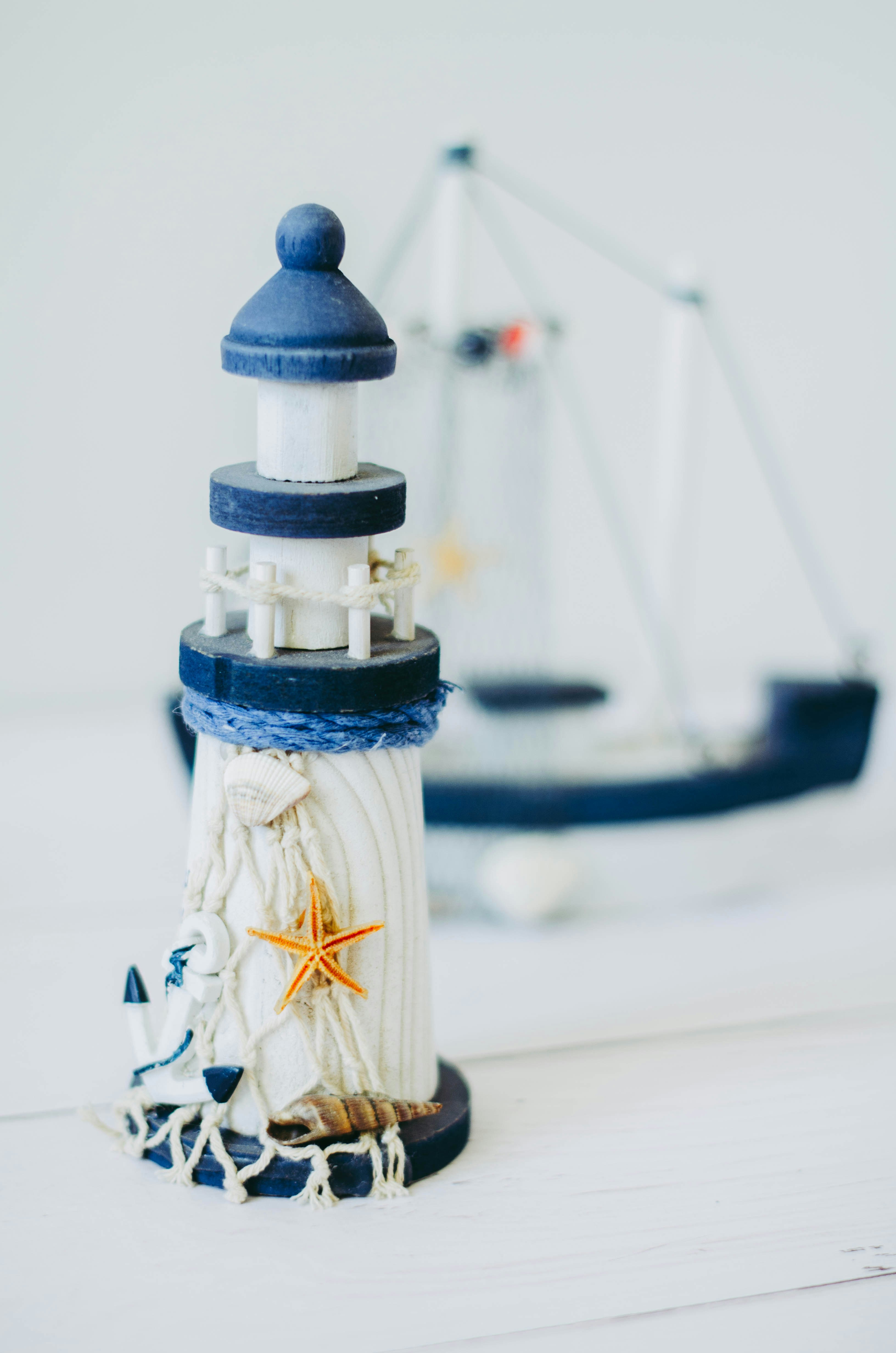 Blue-roofed Lighthouse: a Maritime Miniature Anchored in Focus