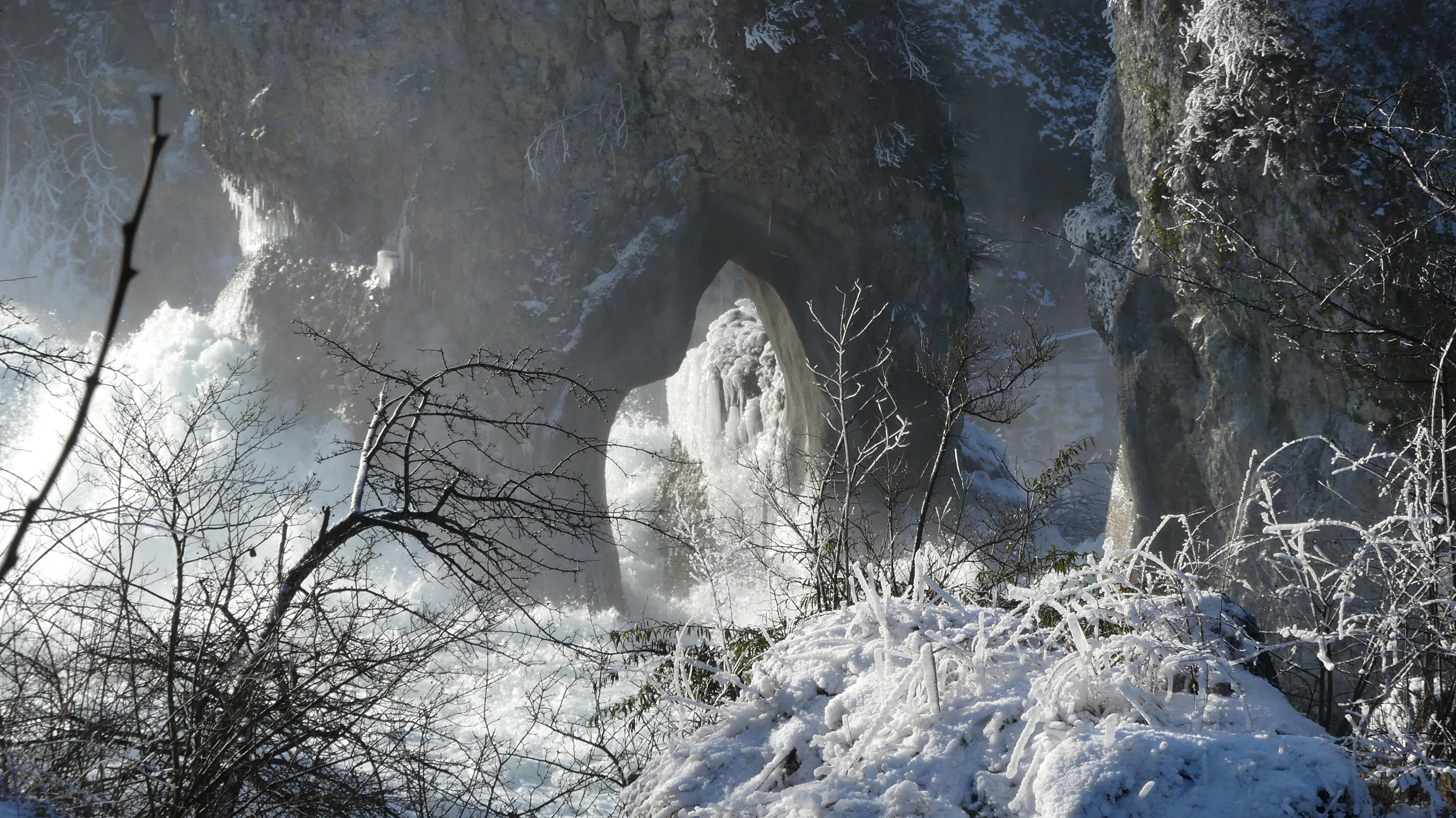 Icebound Archway: Frost Framing a Sea of Spray