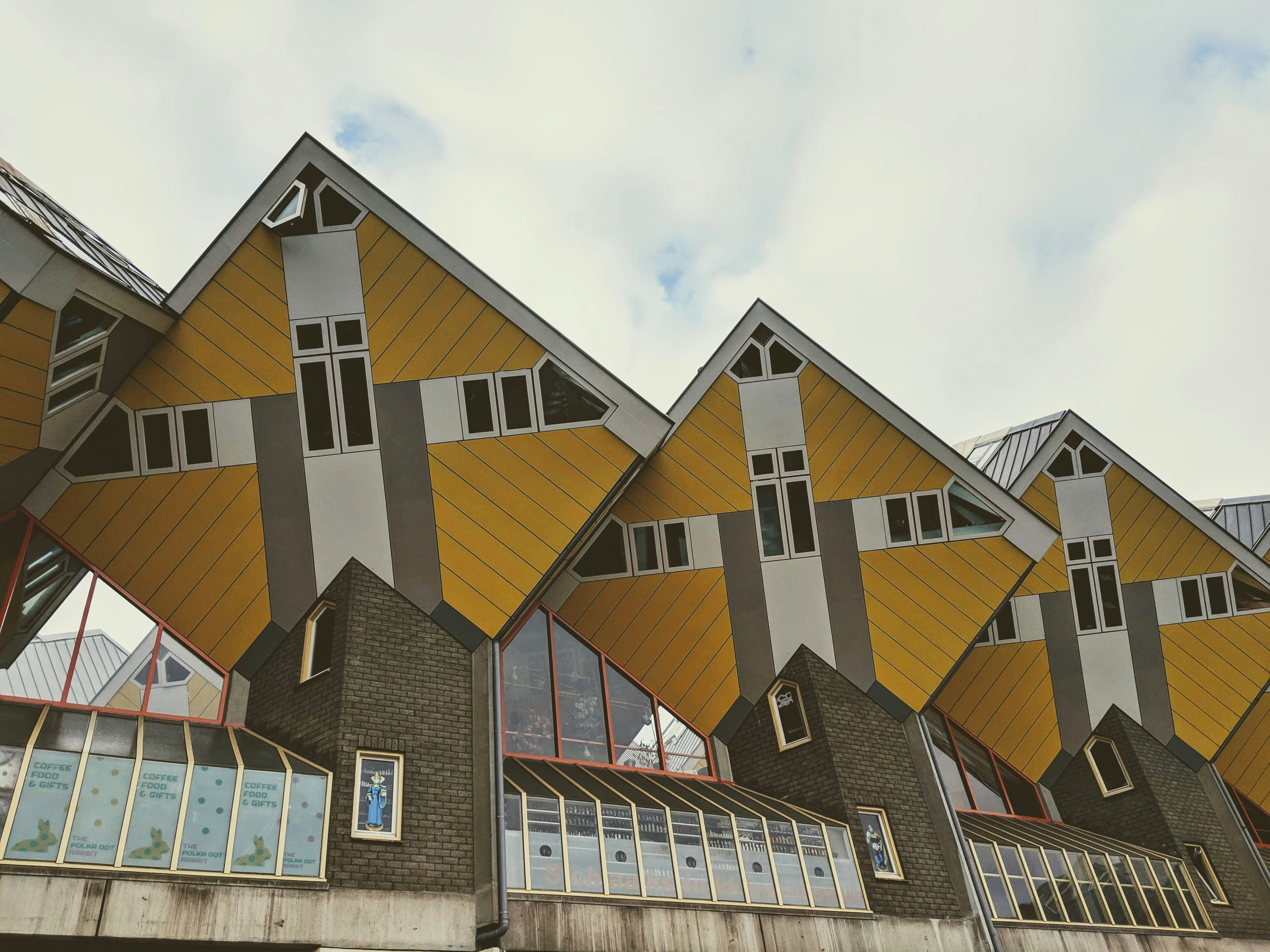 a row of buildings with windows and a sky background