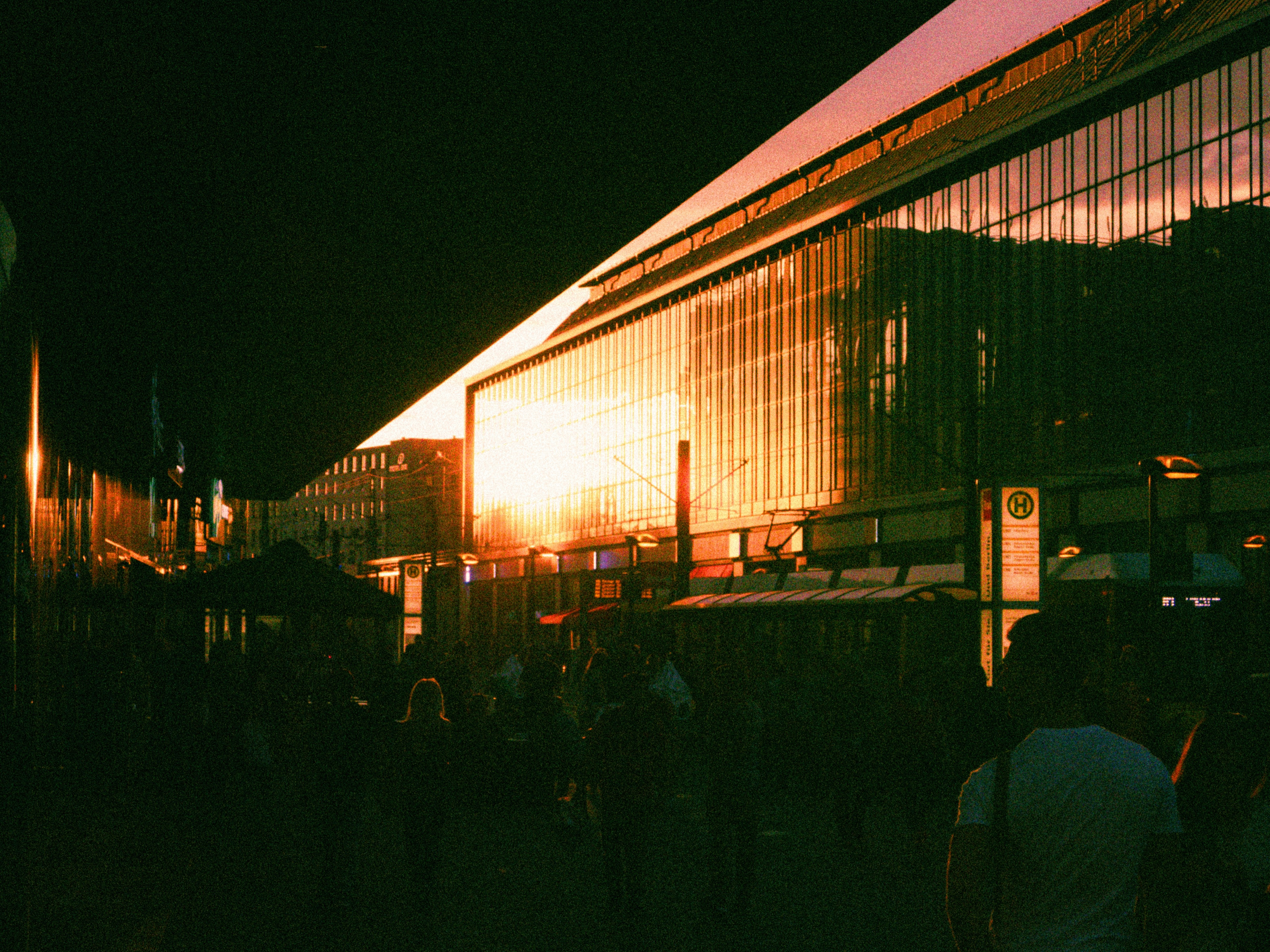Sunlit Glass Wake at a Crowded Transit Hub