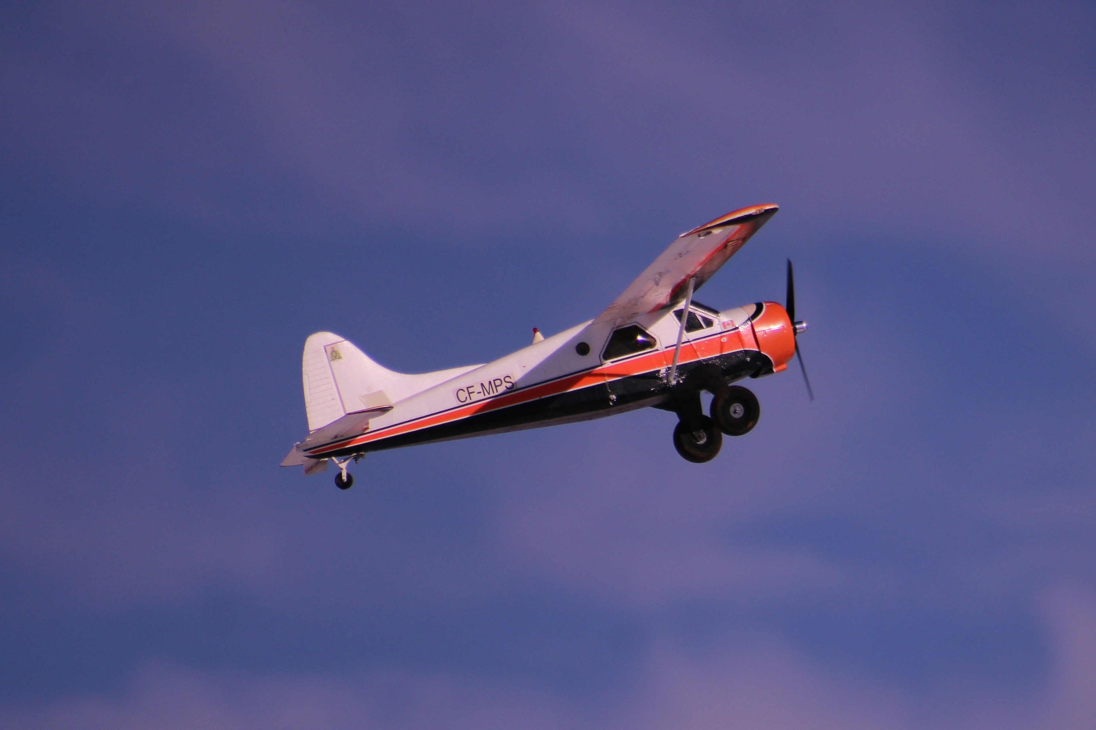 A small airplane flying through a blue sky photo – Free Airplane Image ...