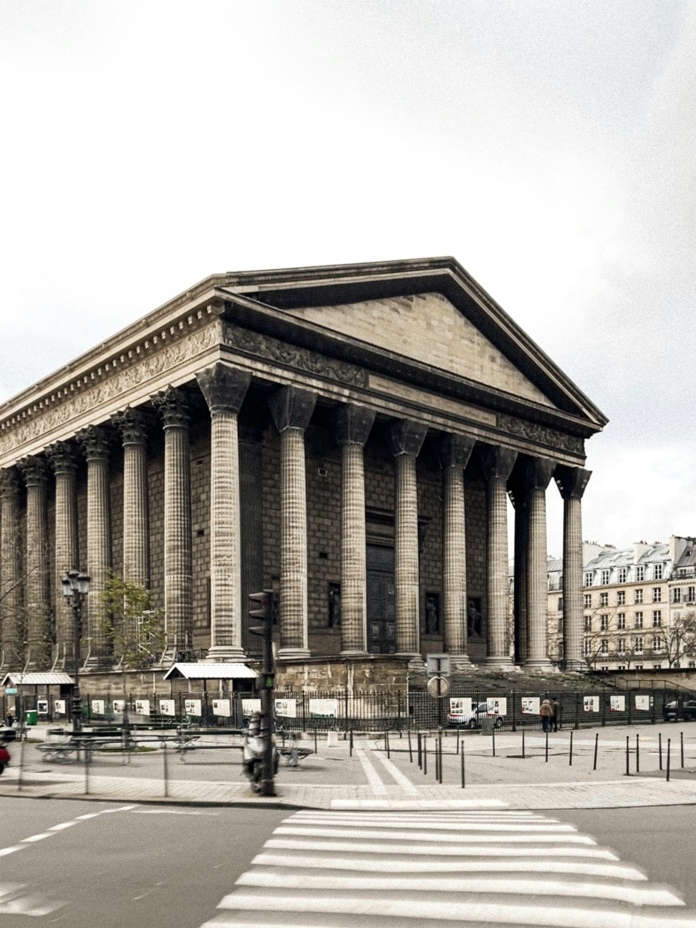 A large building with columns and a crosswalk in front of it photo ...