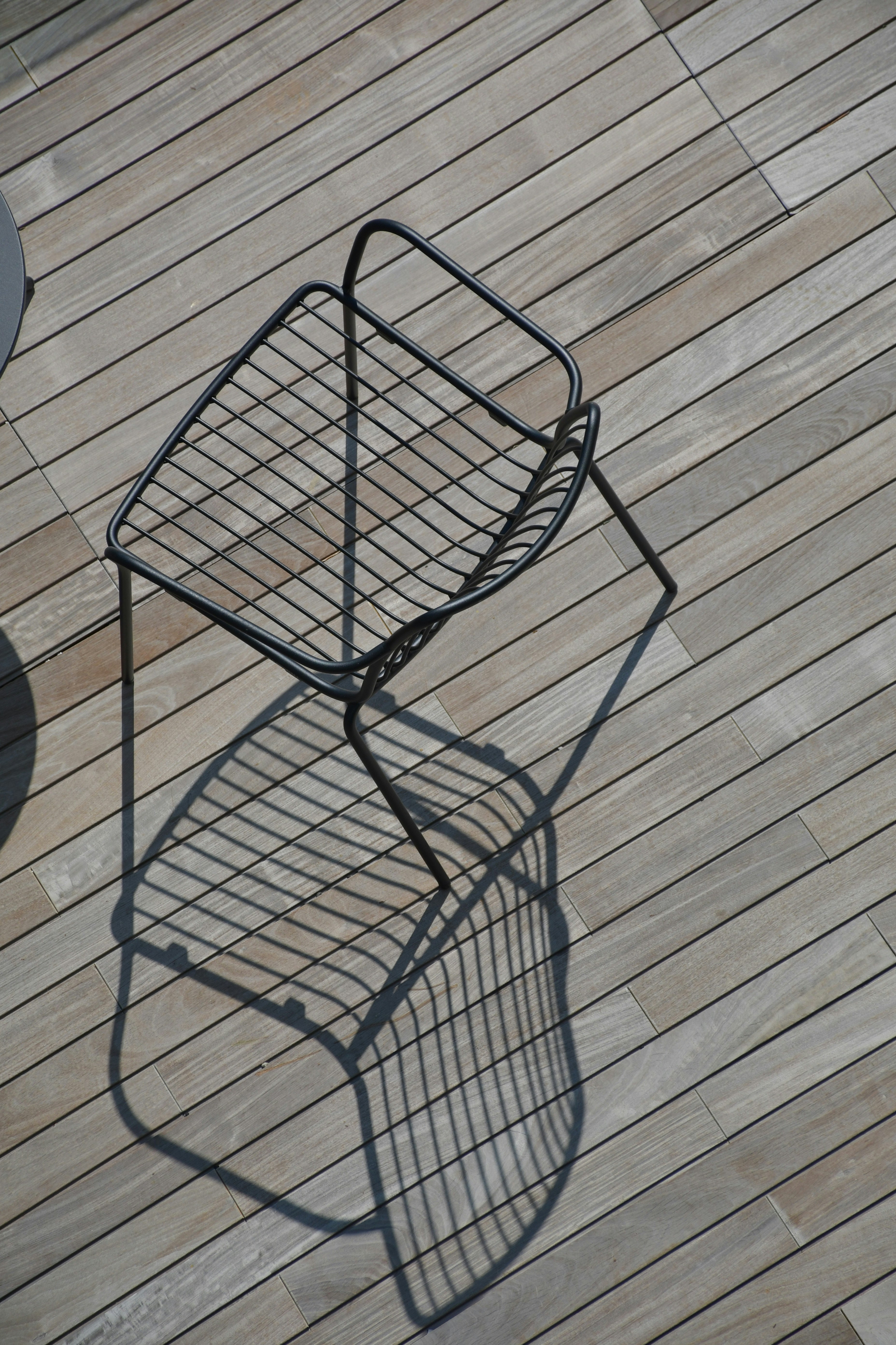 Shadow Geometry of a Woven-Chair on a Sunlit Deck
