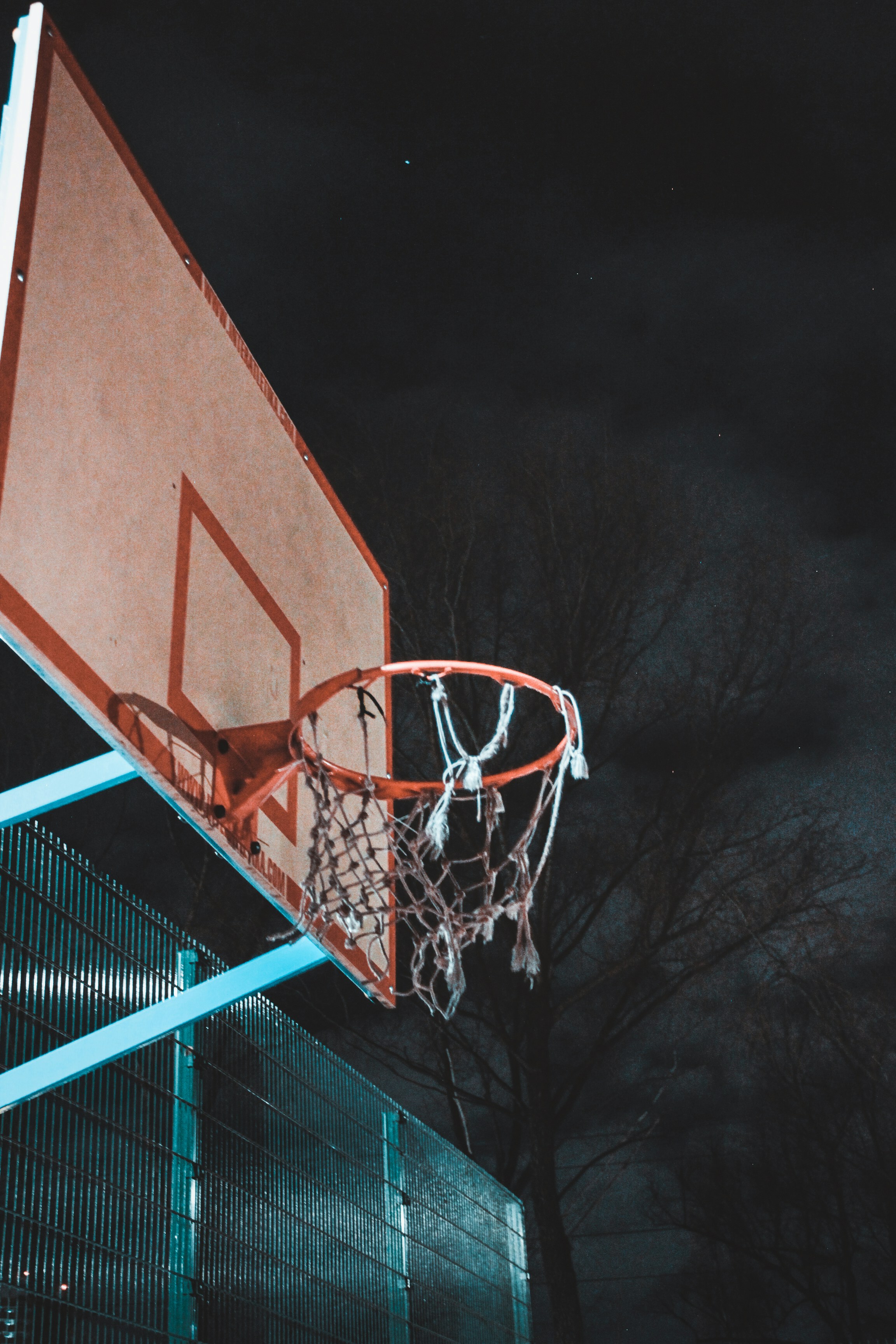 A basketball going through the hoop of a basketball court photo – Free ...