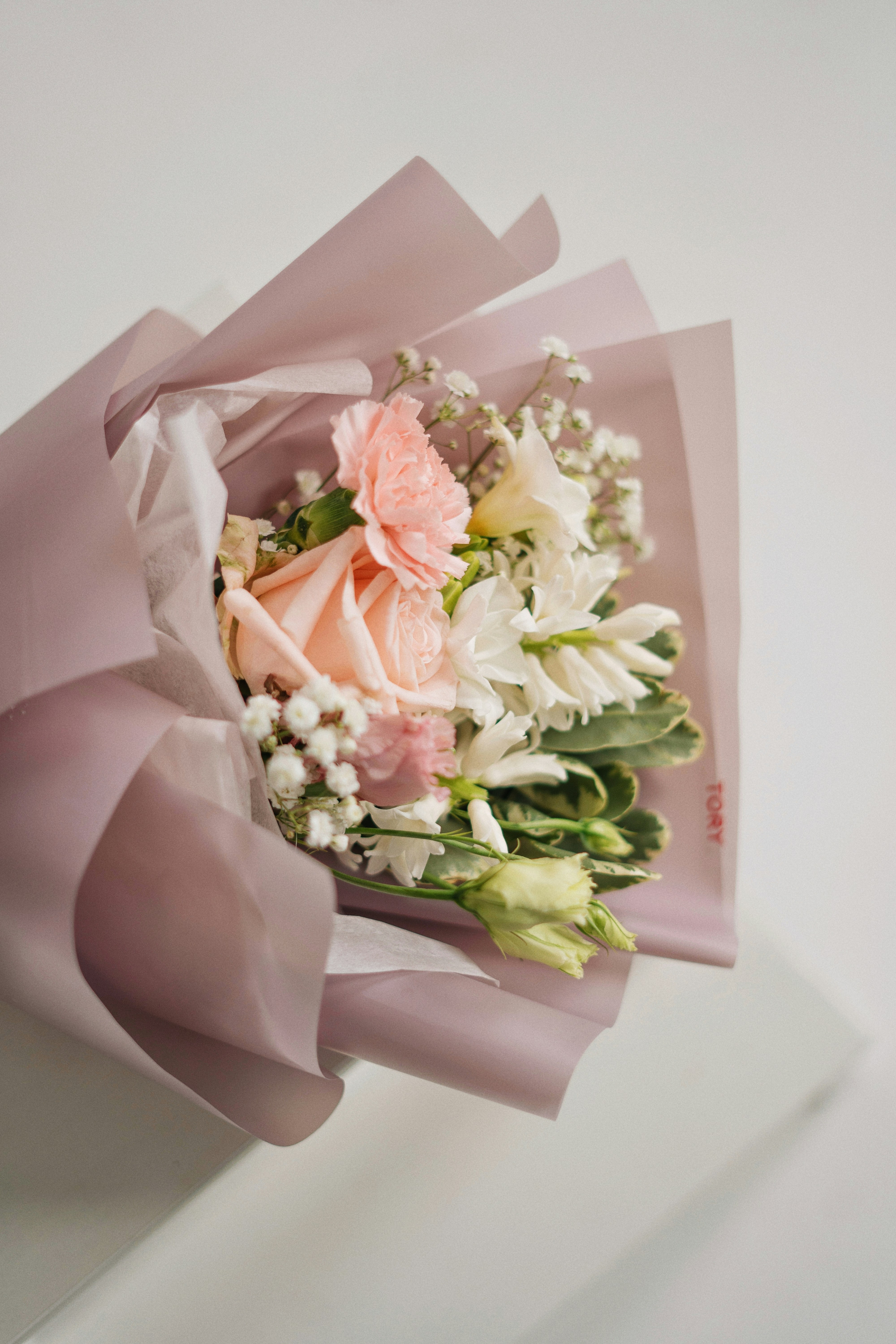 A bouquet of flowers wrapped in pink paper photo – Free Flower ...