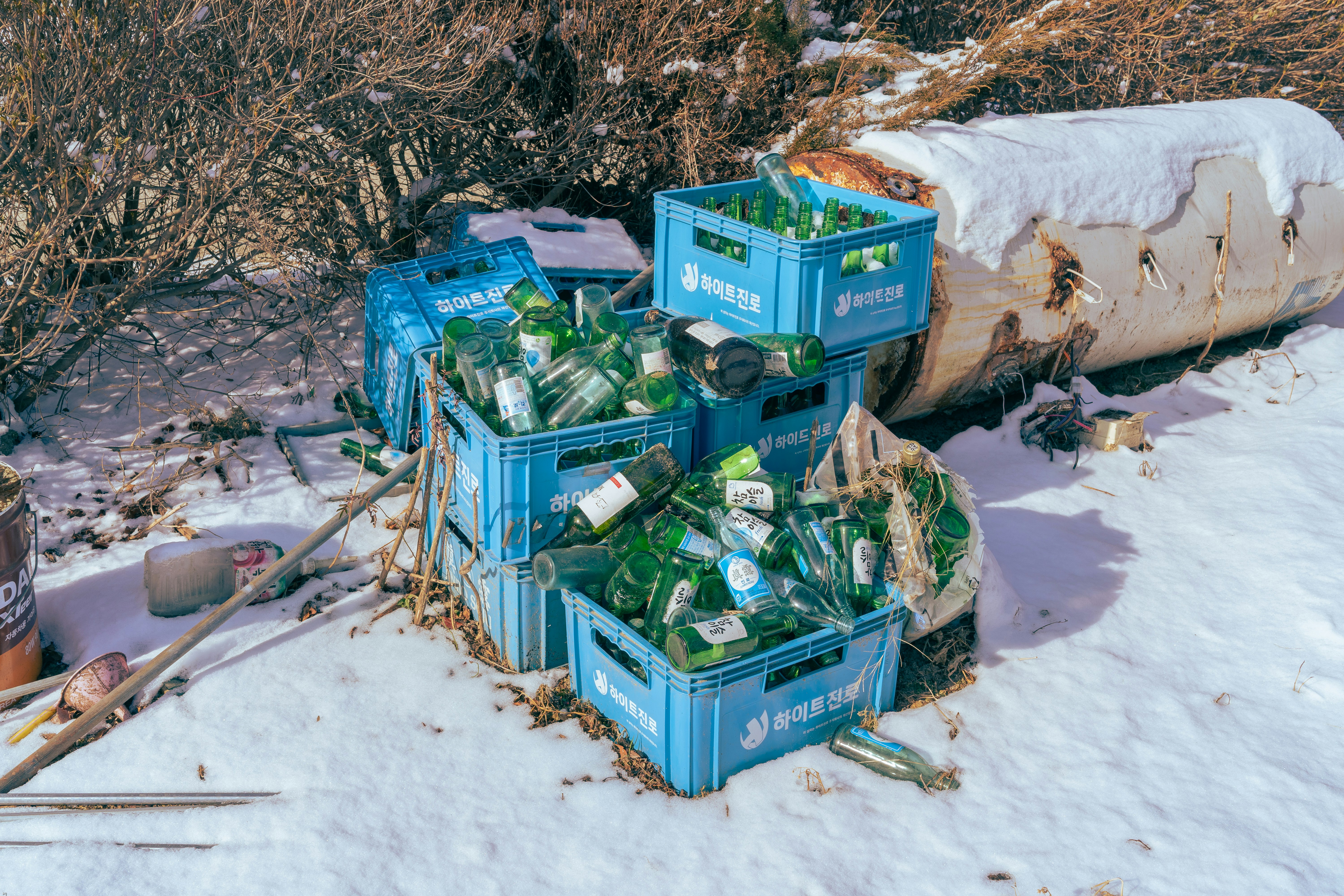 A pile of crates sitting on top of a snow covered ground photo – Free ...